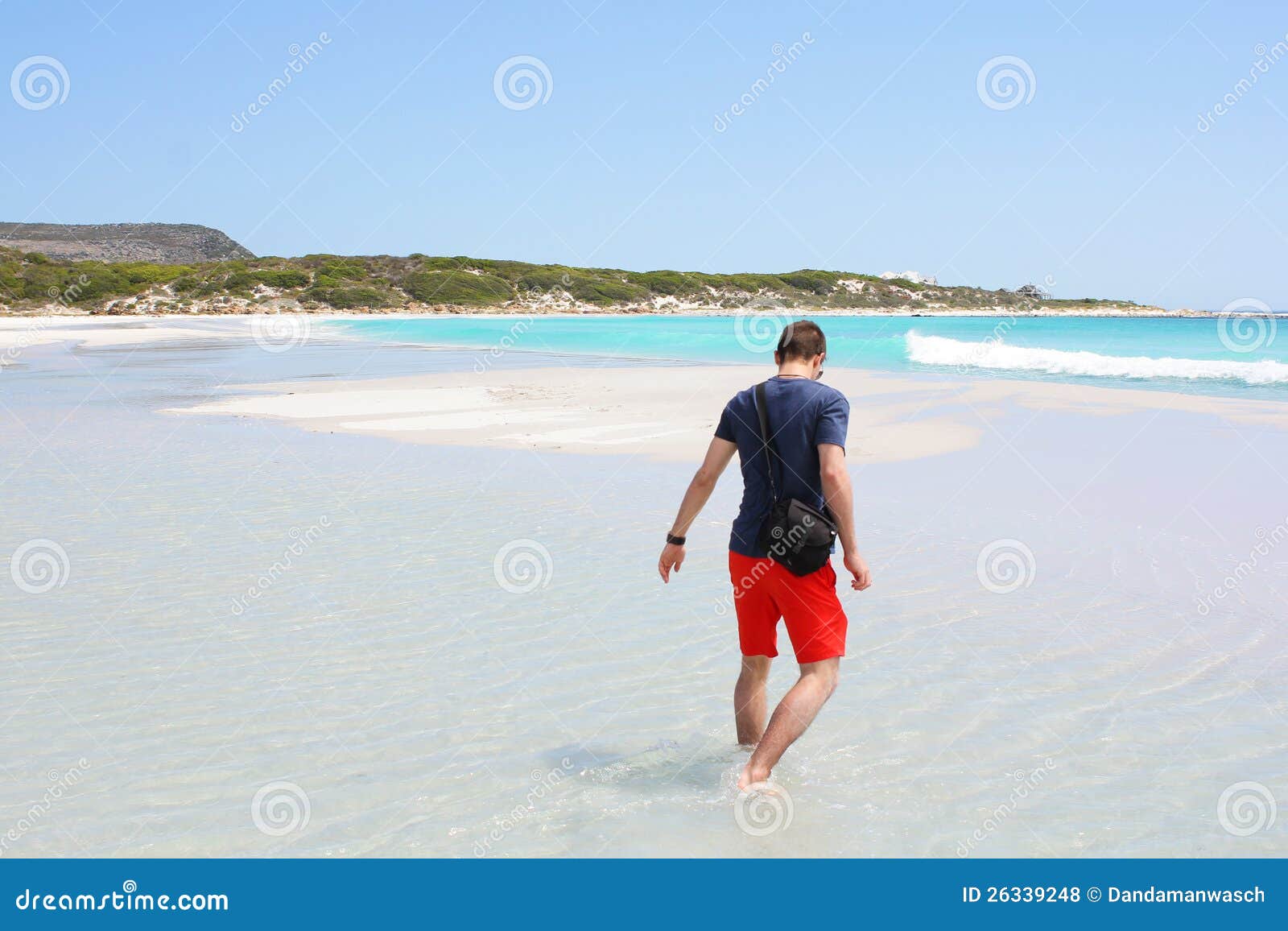 Man walking through water stock photo. Image of person - 26339248