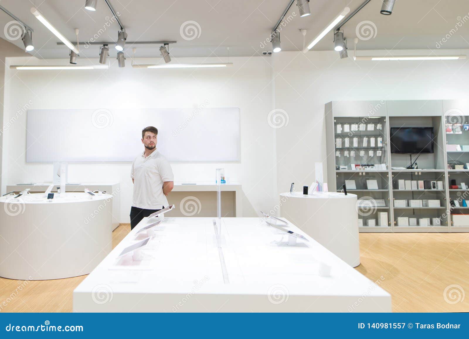 Man Walks on a Light Modern Technology Store. Choosing Gadgets in the ...