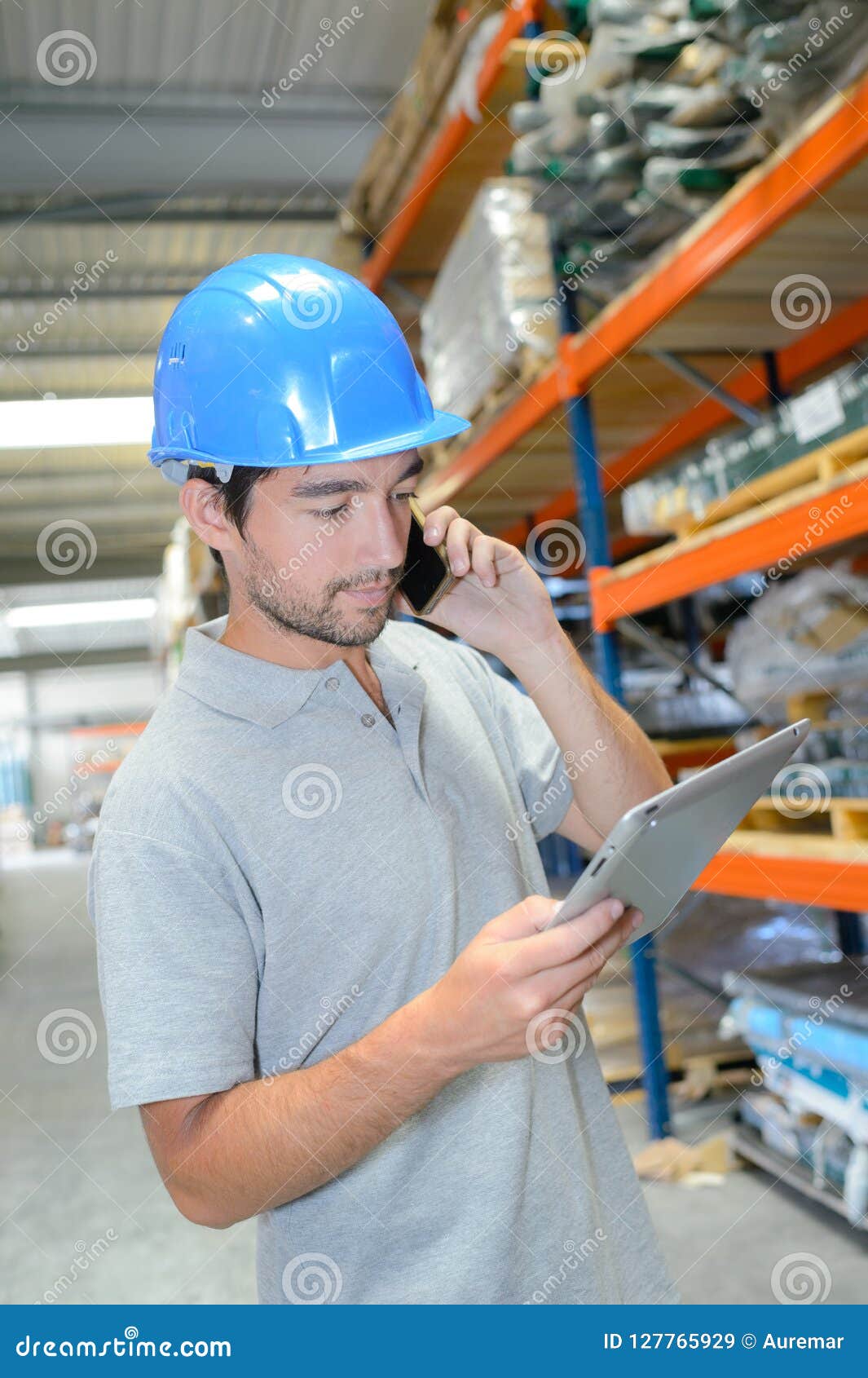 Man in Warehouse Holding Tablet and Talking on Telephone Stock Image ...