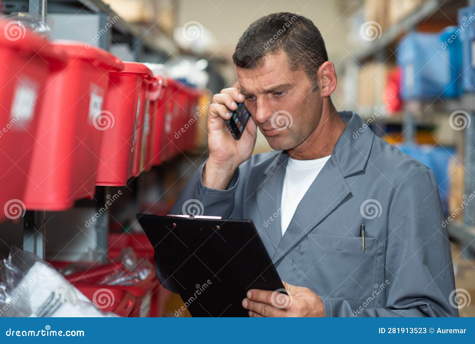 Man in Warehouse on Telephone Looking Concerned Stock Image - Image of ...