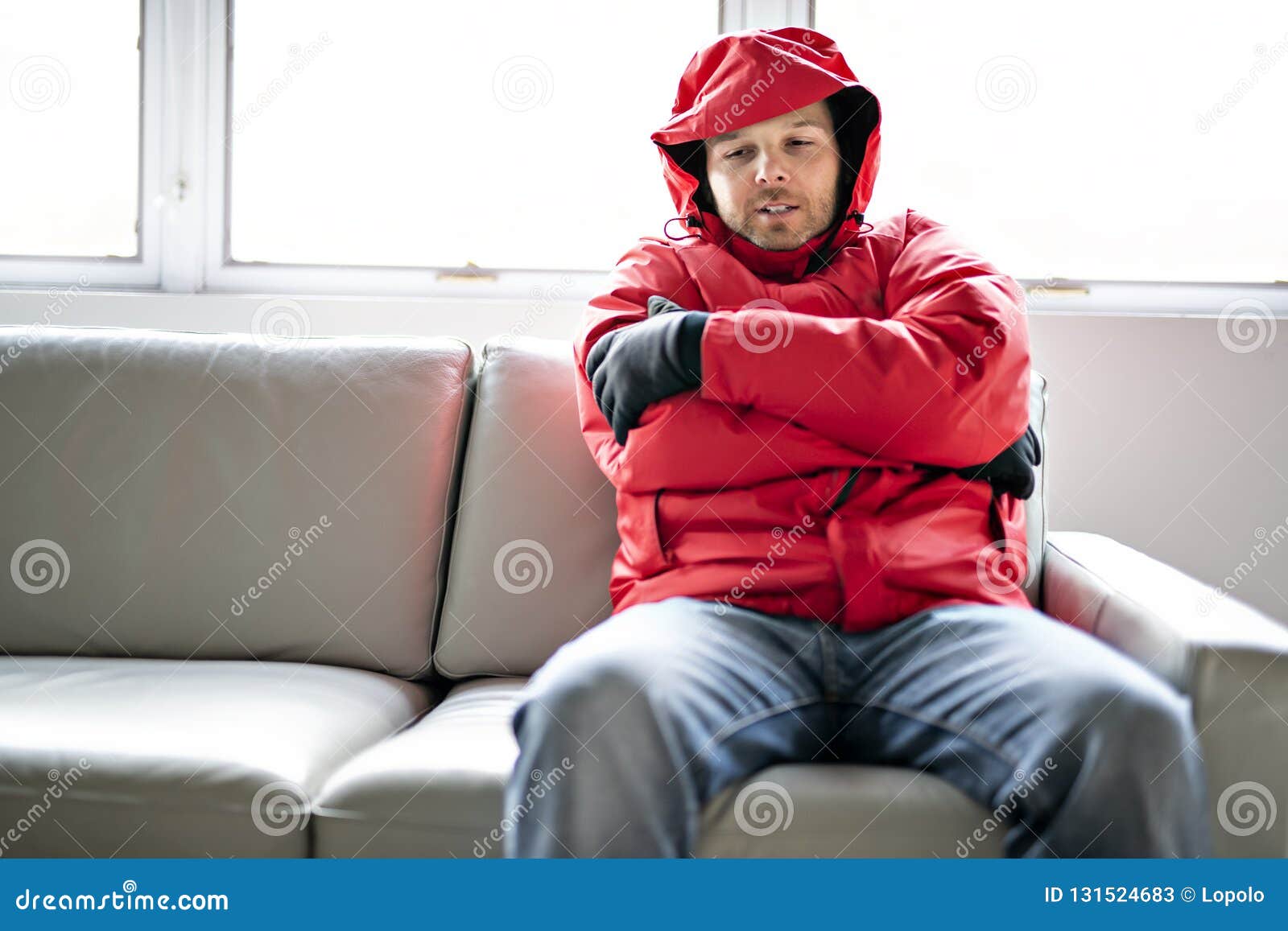 A Man with Warm Clothing Feeling the Cold Inside House on the Sofa ...
