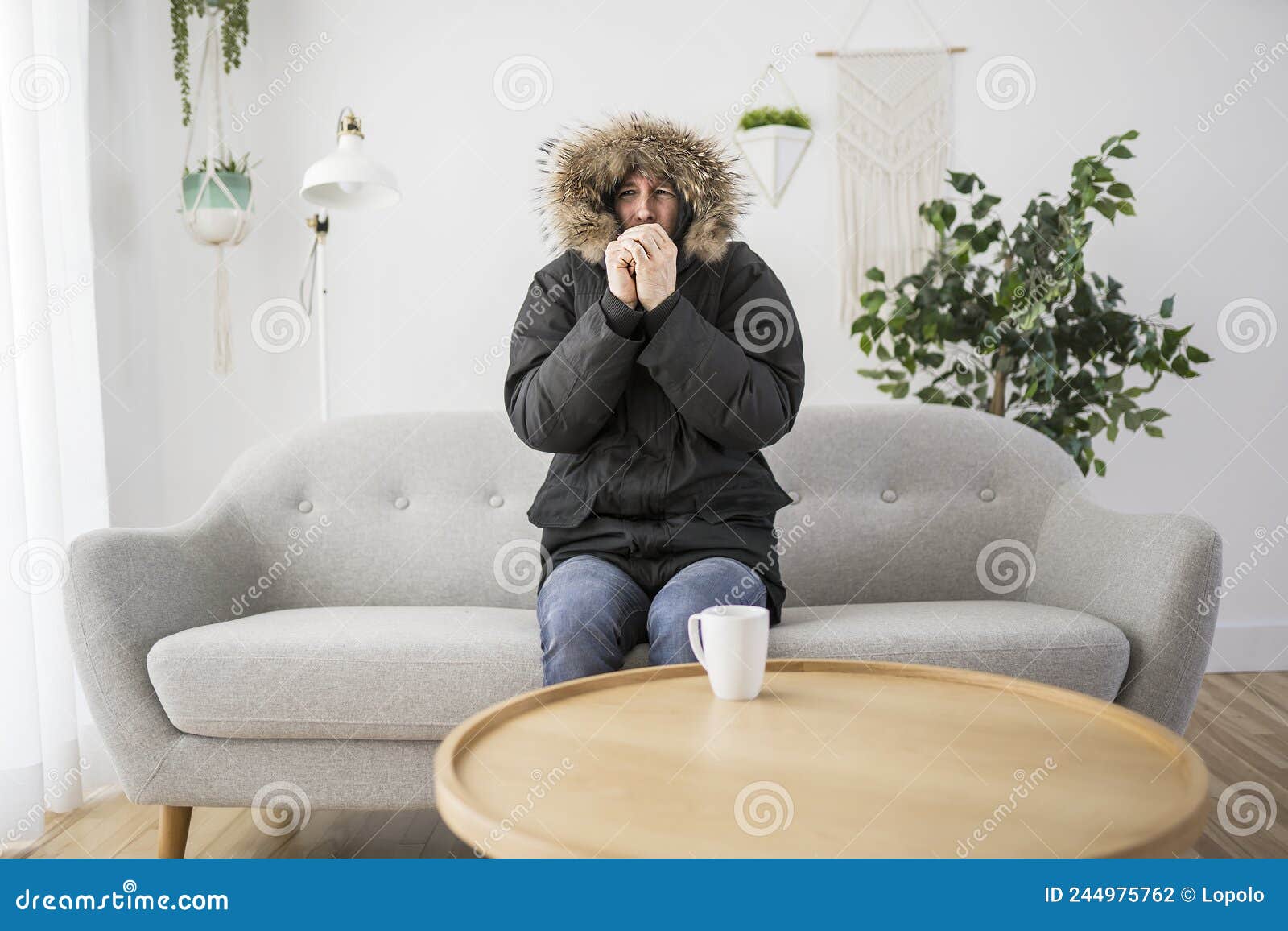 Man with Warm Clothing Feeling the Cold Inside House on the Sofa Stock ...