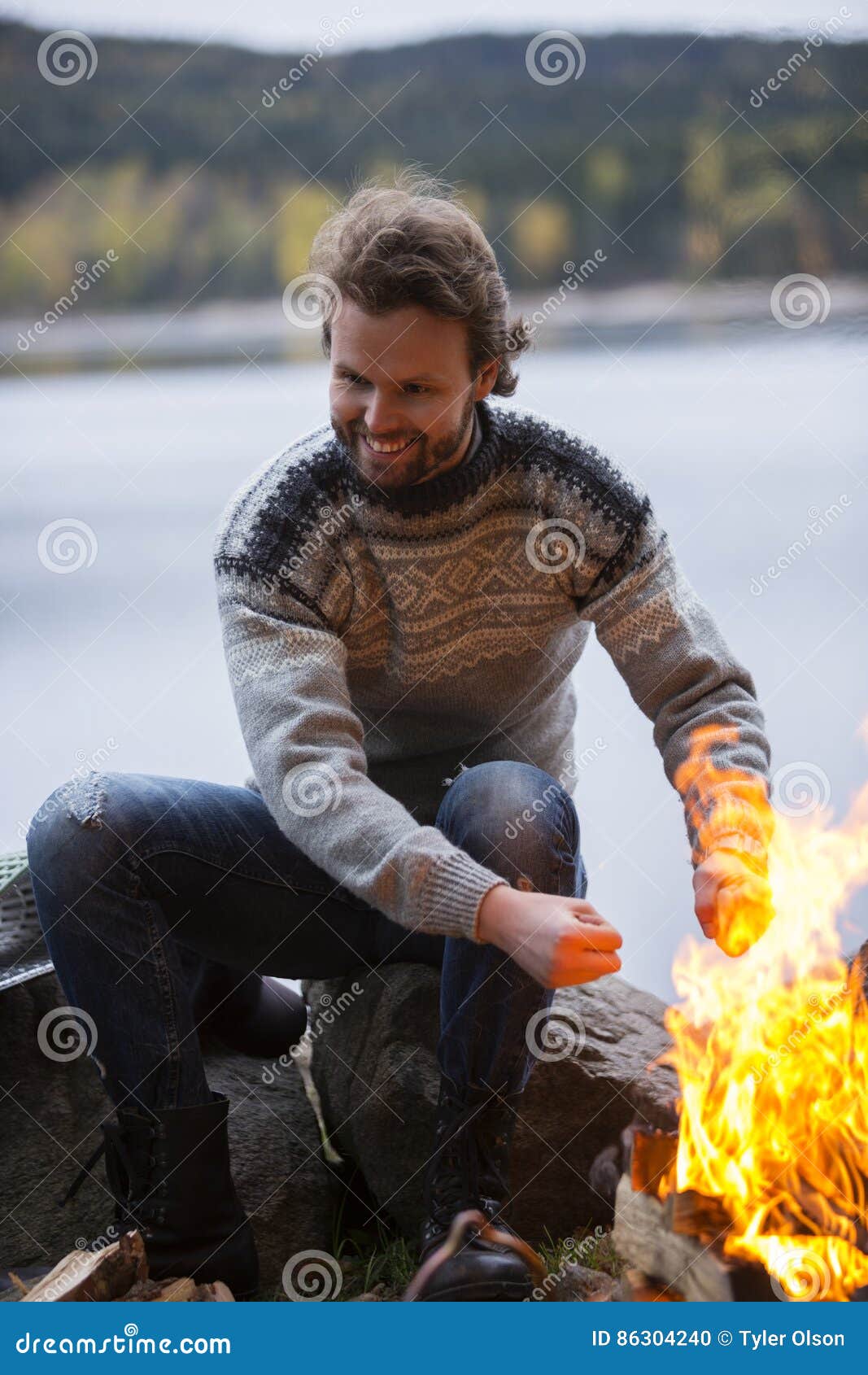 Man Warming Hands by Bonfire on Lakeside Camping Stock Photo - Image of ...