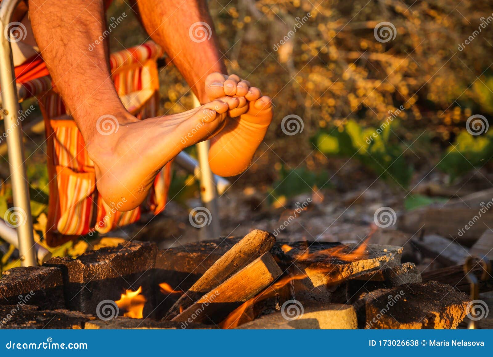 Man Warms His Bare Feet Over the Fire of BBQ Stock Photo - Image of ...