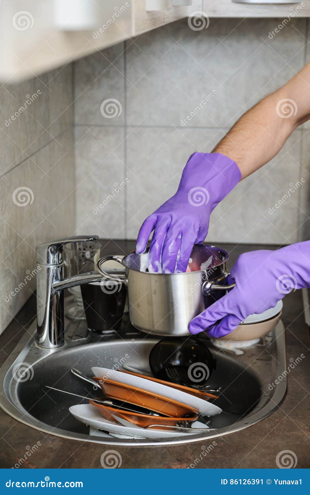 A man washes dishes. stock image. Image of housework - 86126391