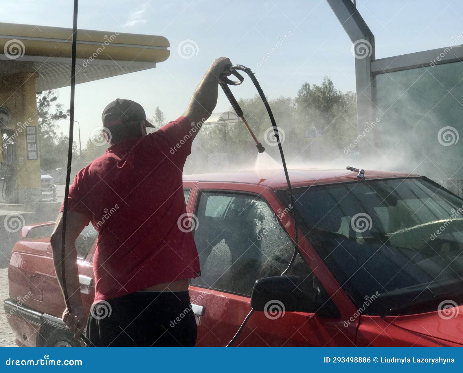 A Man Washes a Red Car at a Car Wash with Detergent. Stock Photo ...