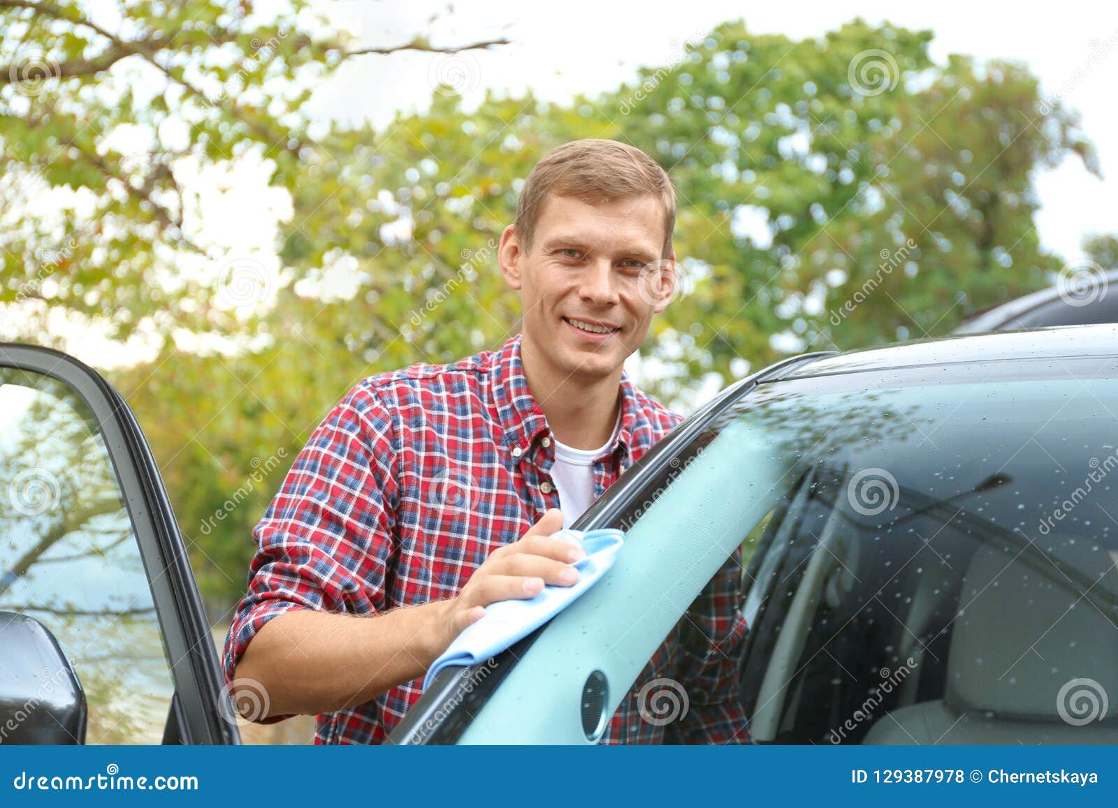 Man washing car windshield stock photo. Image of filth - 129387978