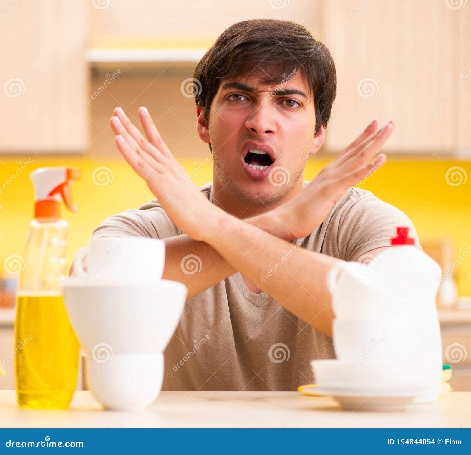 Man washing dishes at home stock photo. Image of chores - 194844054