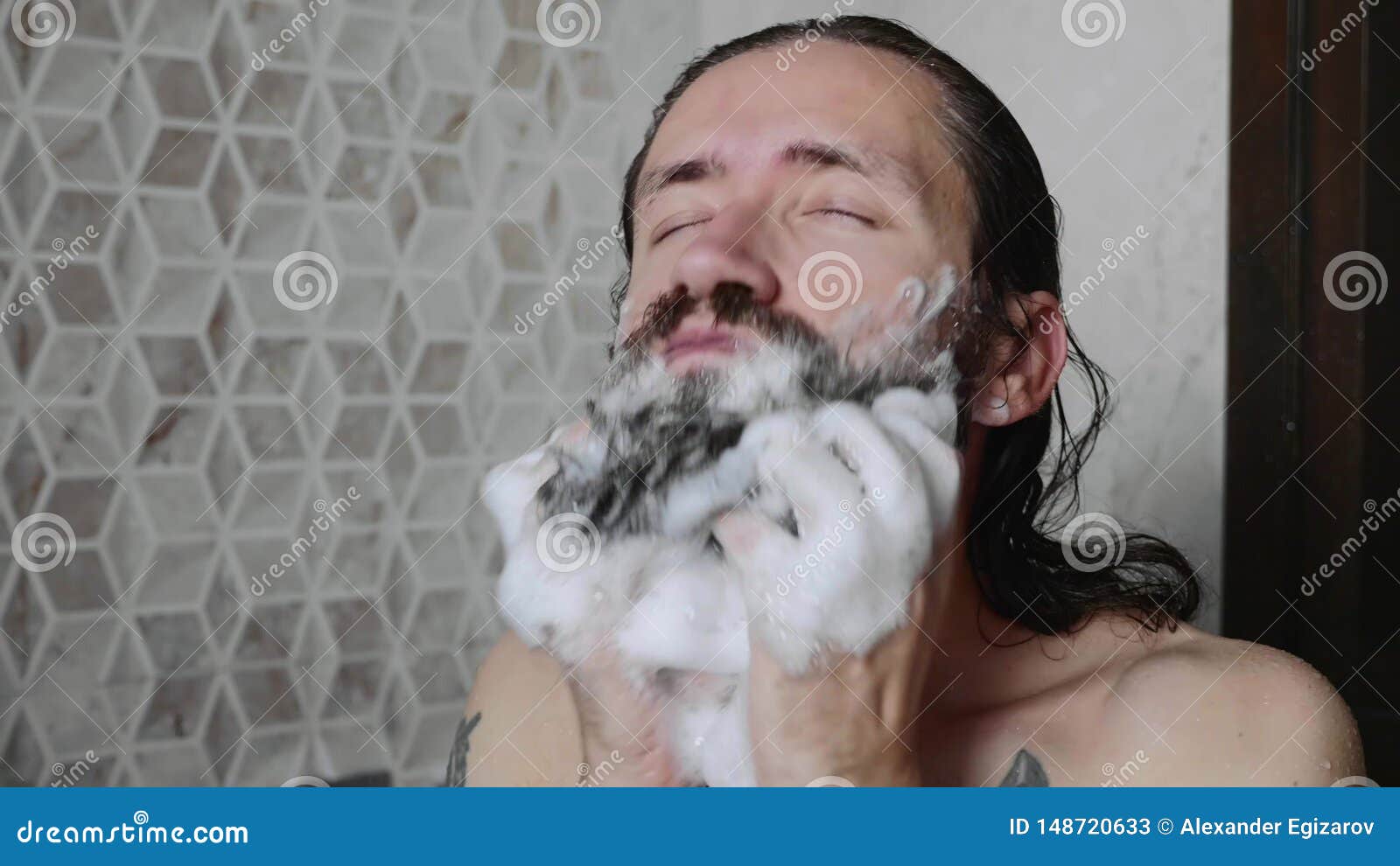 Man Is Washing His Beard With Shampoo And Foam In The Shower Stock