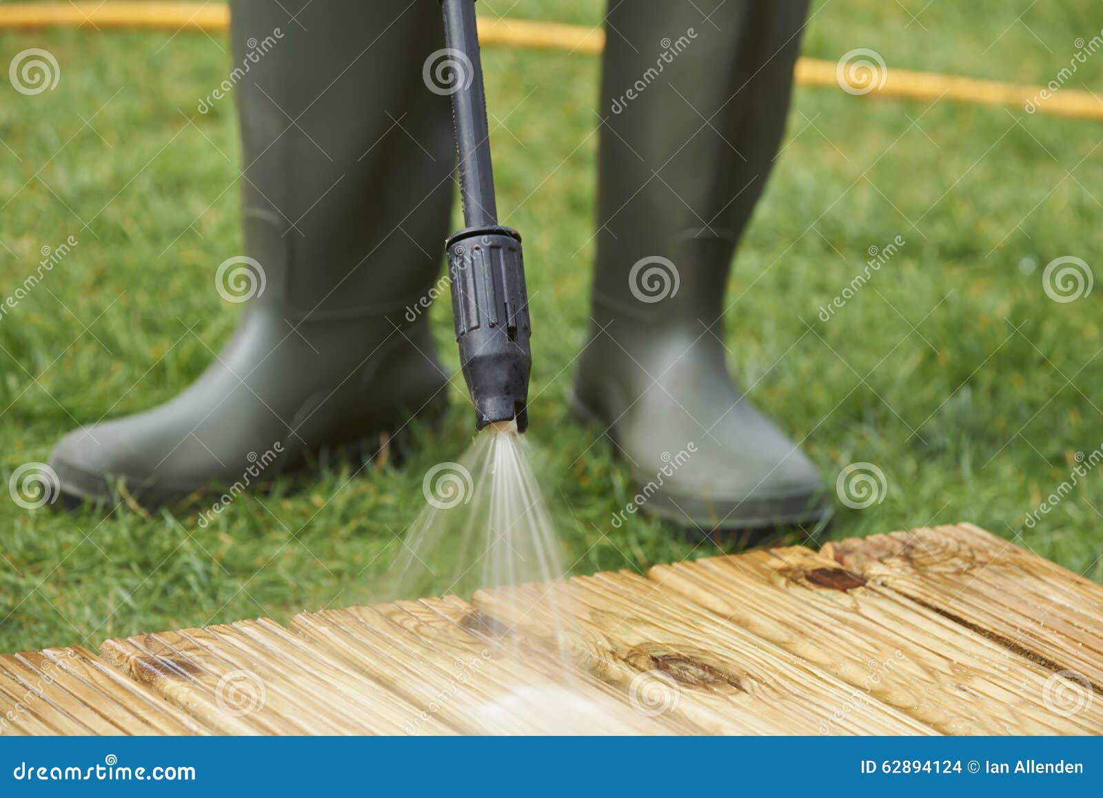 Man Washing Wooden Decking With Pressure Washer Stock Photo ...