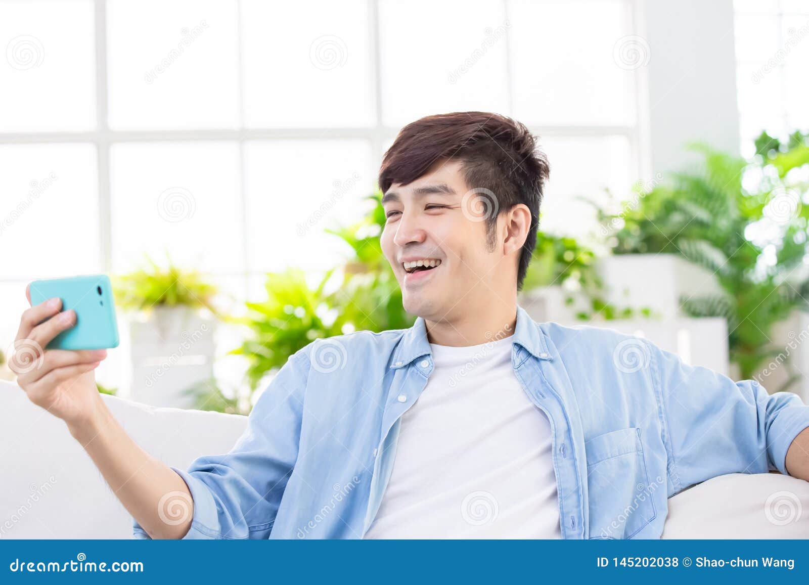 Man watch video with phone stock photo. Image of internet - 145202038