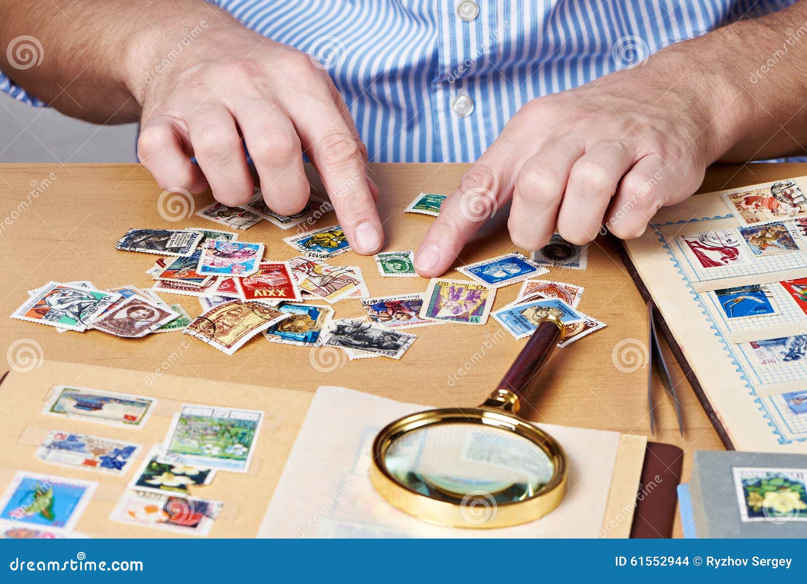 Man Watching a Collection of Postage Stamps Editorial Stock Image ...