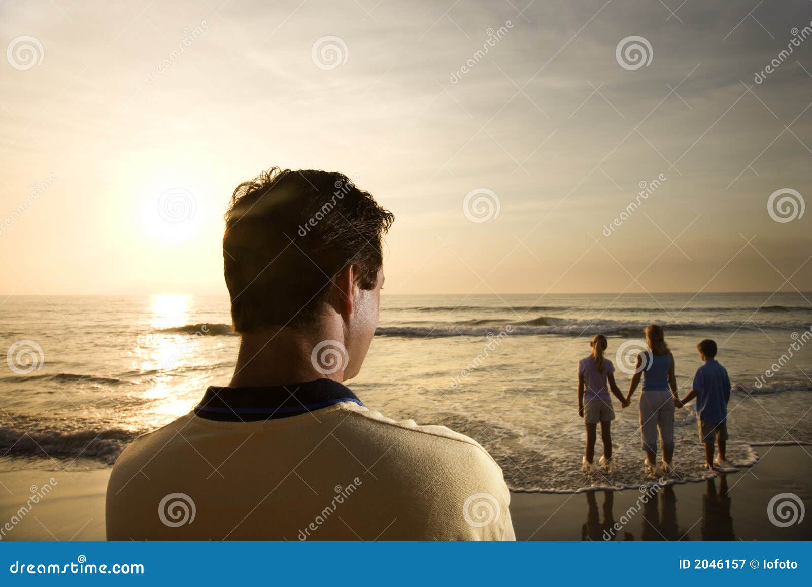 Man Watching Family at Beach Stock Image - Image of outdoors, coast ...