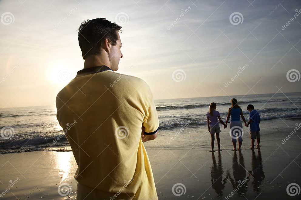 Man Watching Family at Beach Stock Photo - Image of vacation, person ...