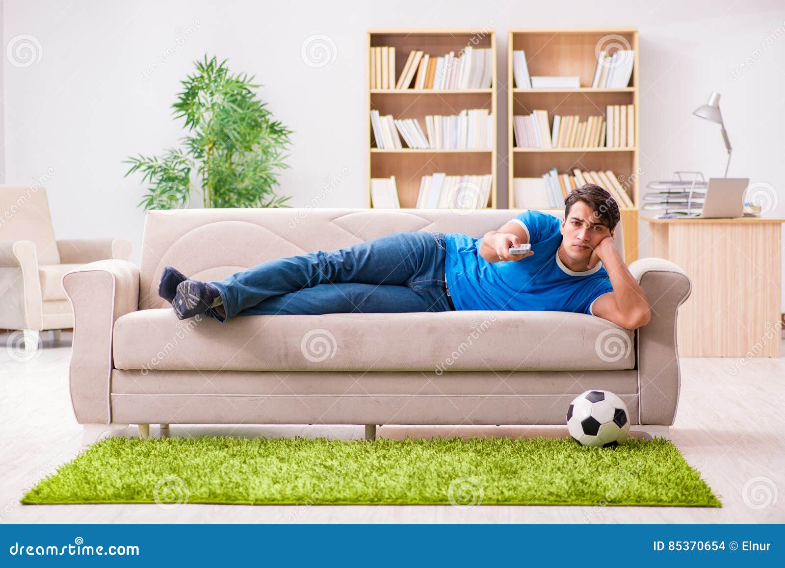 The Man Watching Football at Home Sitting in Couch Stock Photo - Image ...