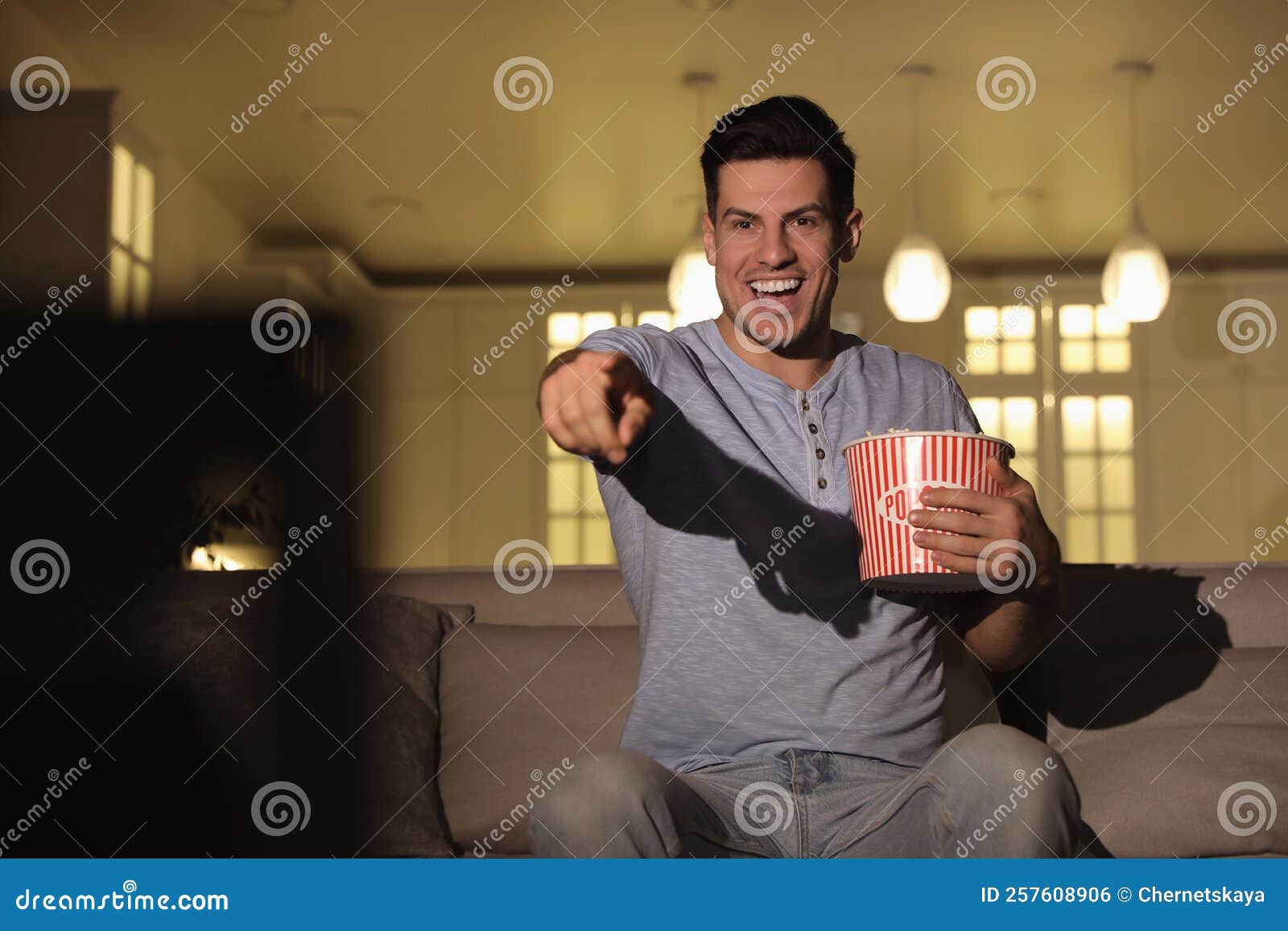 Man Watching Movie with Popcorn on Sofa at Night Stock Photo - Image of ...