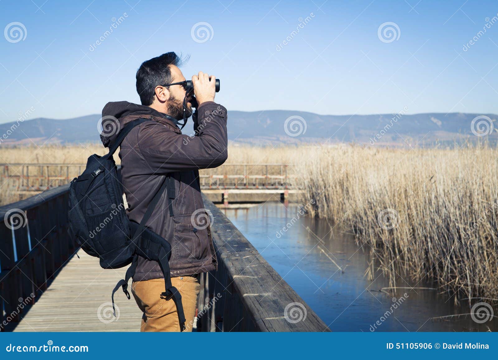 Man Watching Nature with Binoculars, in a Wood Bridge Stock Photo ... Man Watching Nature with Binoculars, in a Wood Bridge Stock Photo ...