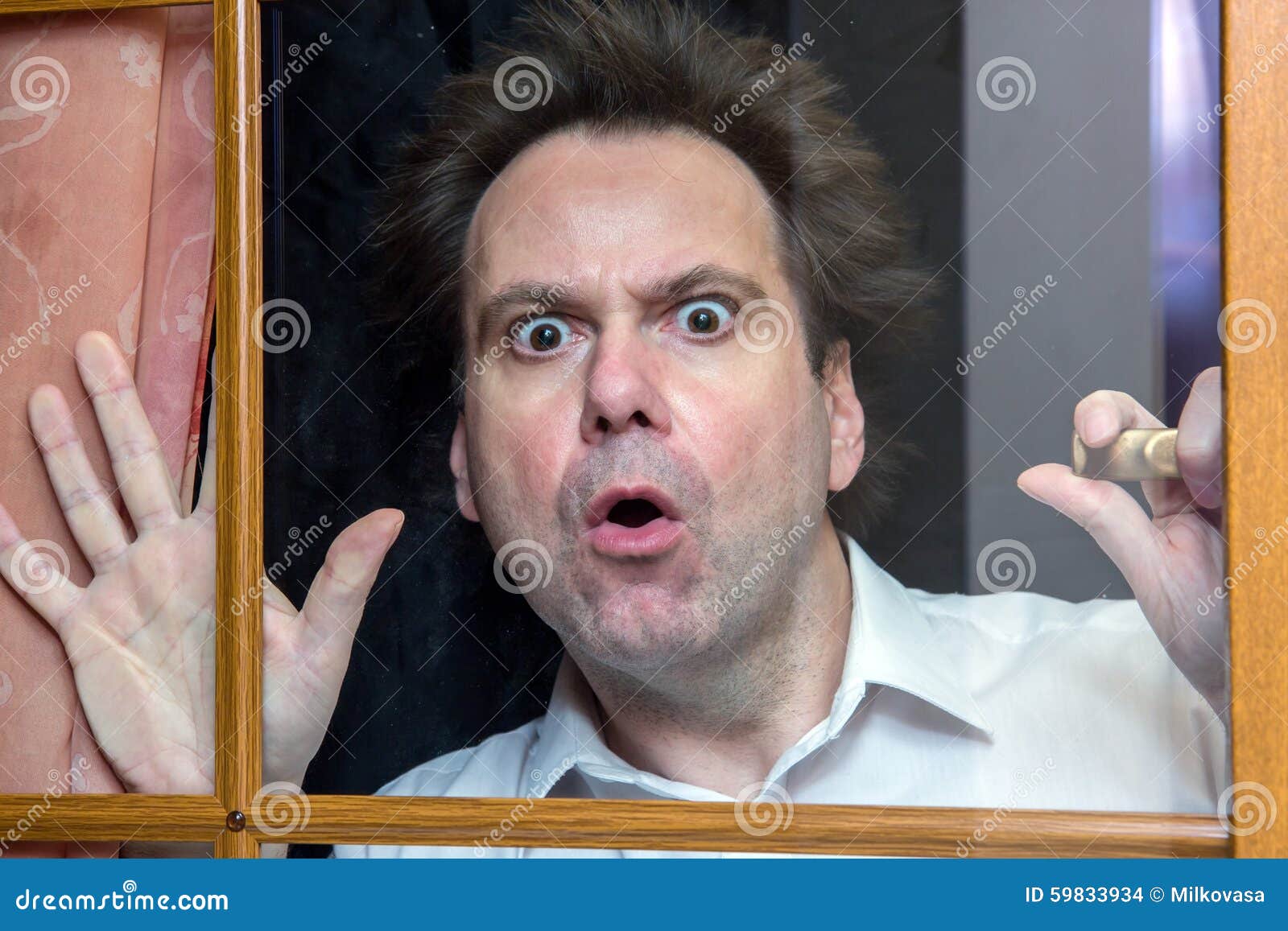 Man Looking Through A Window