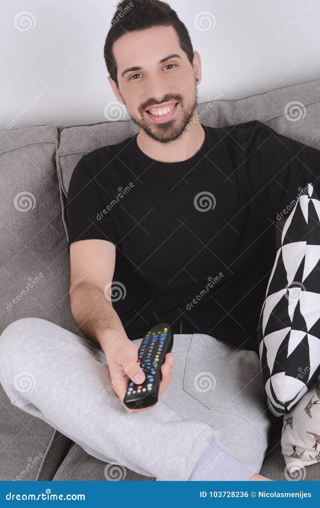 Man watching tv on couch. stock photo. Image of entertaining - 103728236
