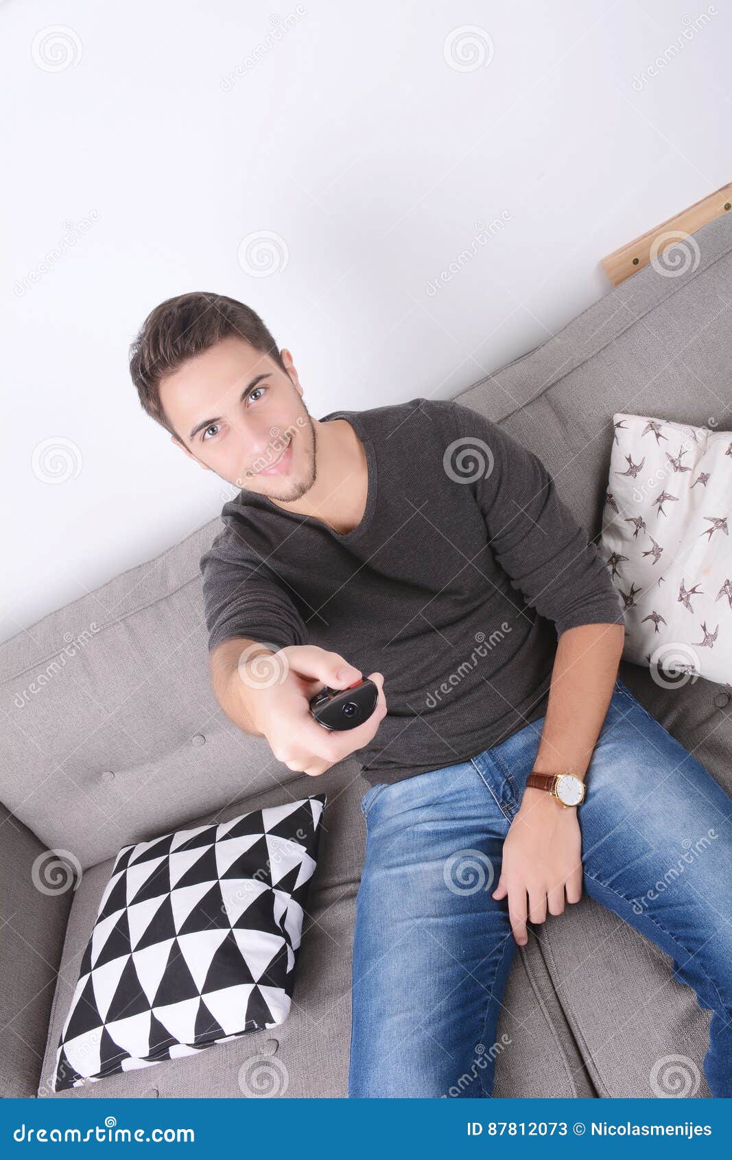 Man watching tv on couch. stock image. Image of couch - 87812073