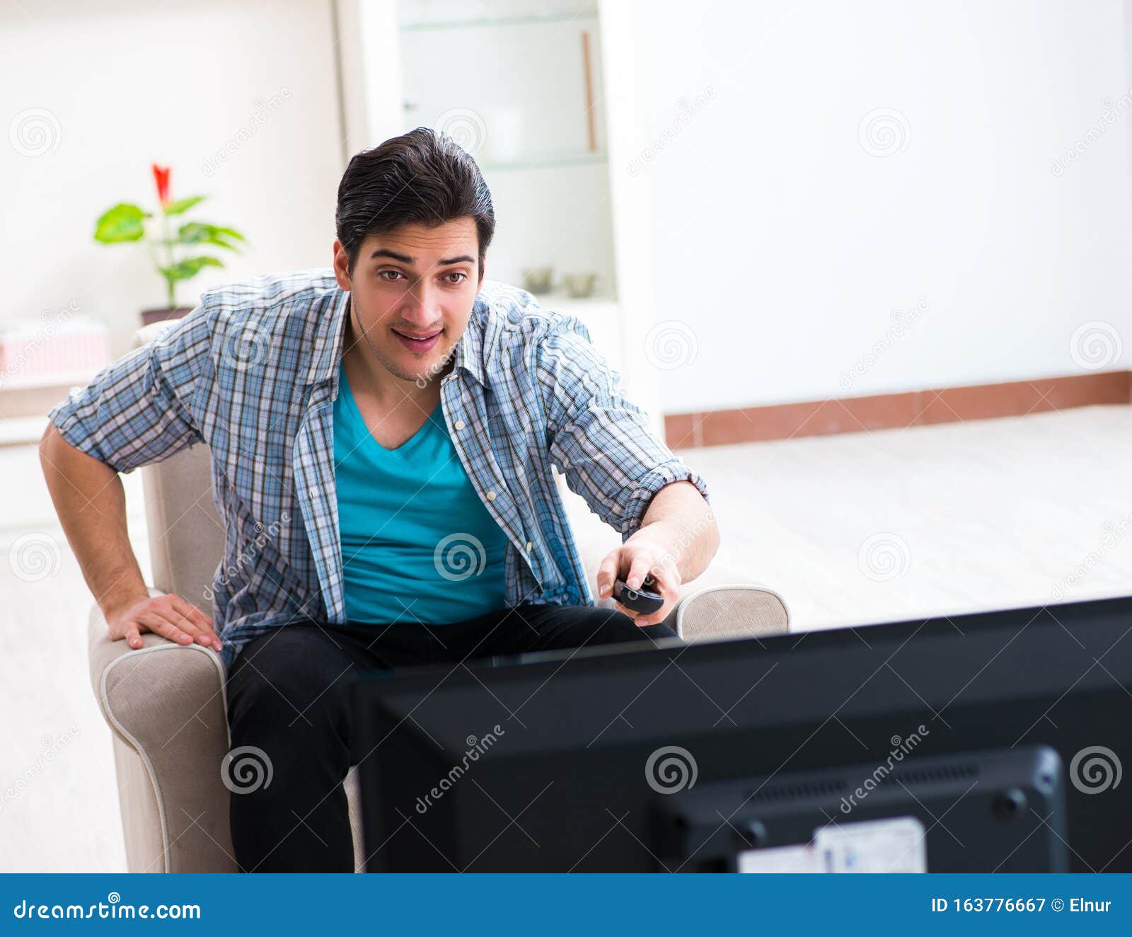 Man watching tv at home stock image. Image of channel - 163776667