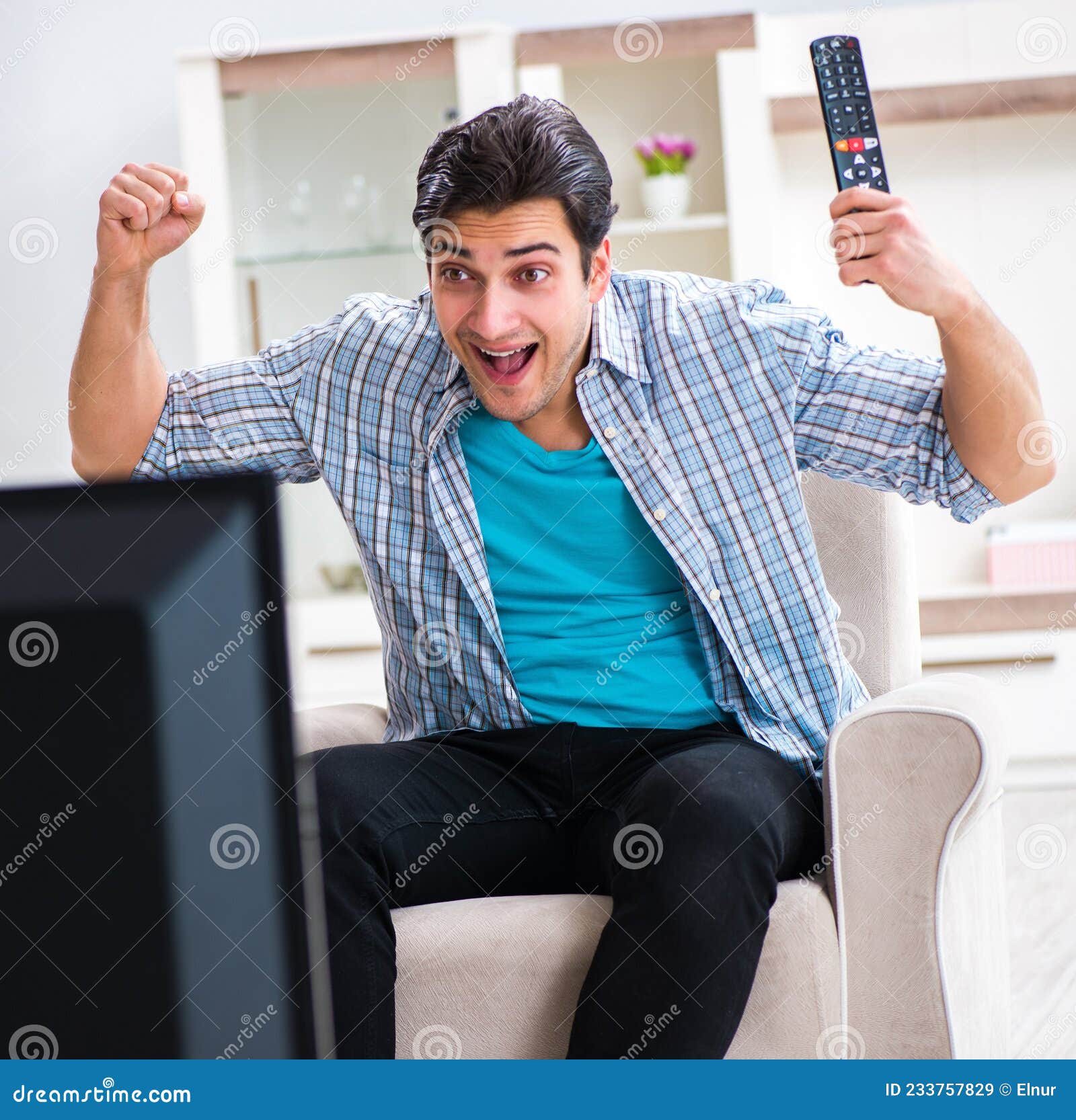Man watching tv at home stock image. Image of excited - 233757829