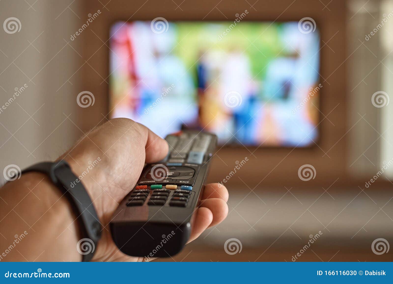 Man Watching TV in the Room and Switches Channels Using the Remote ...