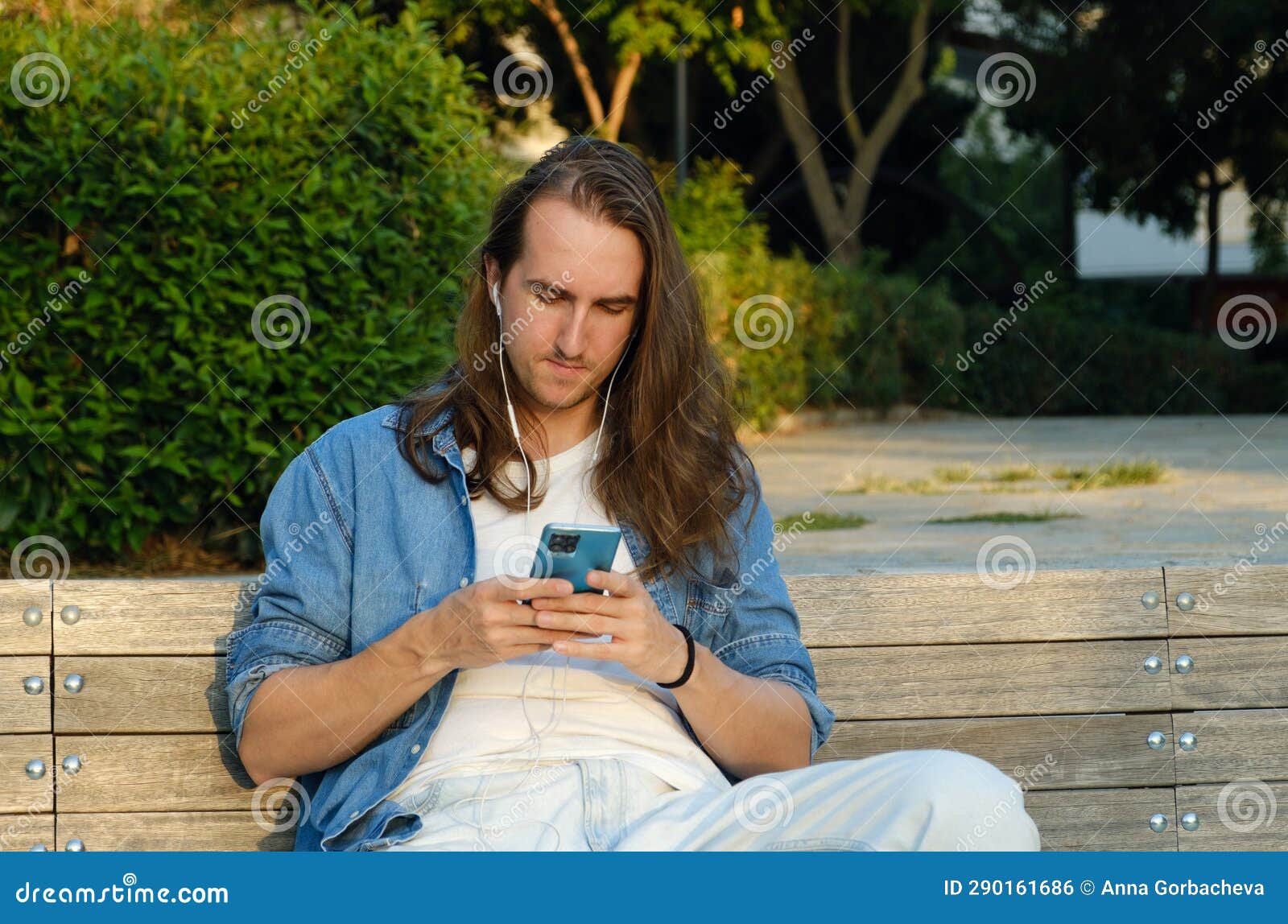 Man Watching Video on His Phone Stock Photo - Image of outdoors ...