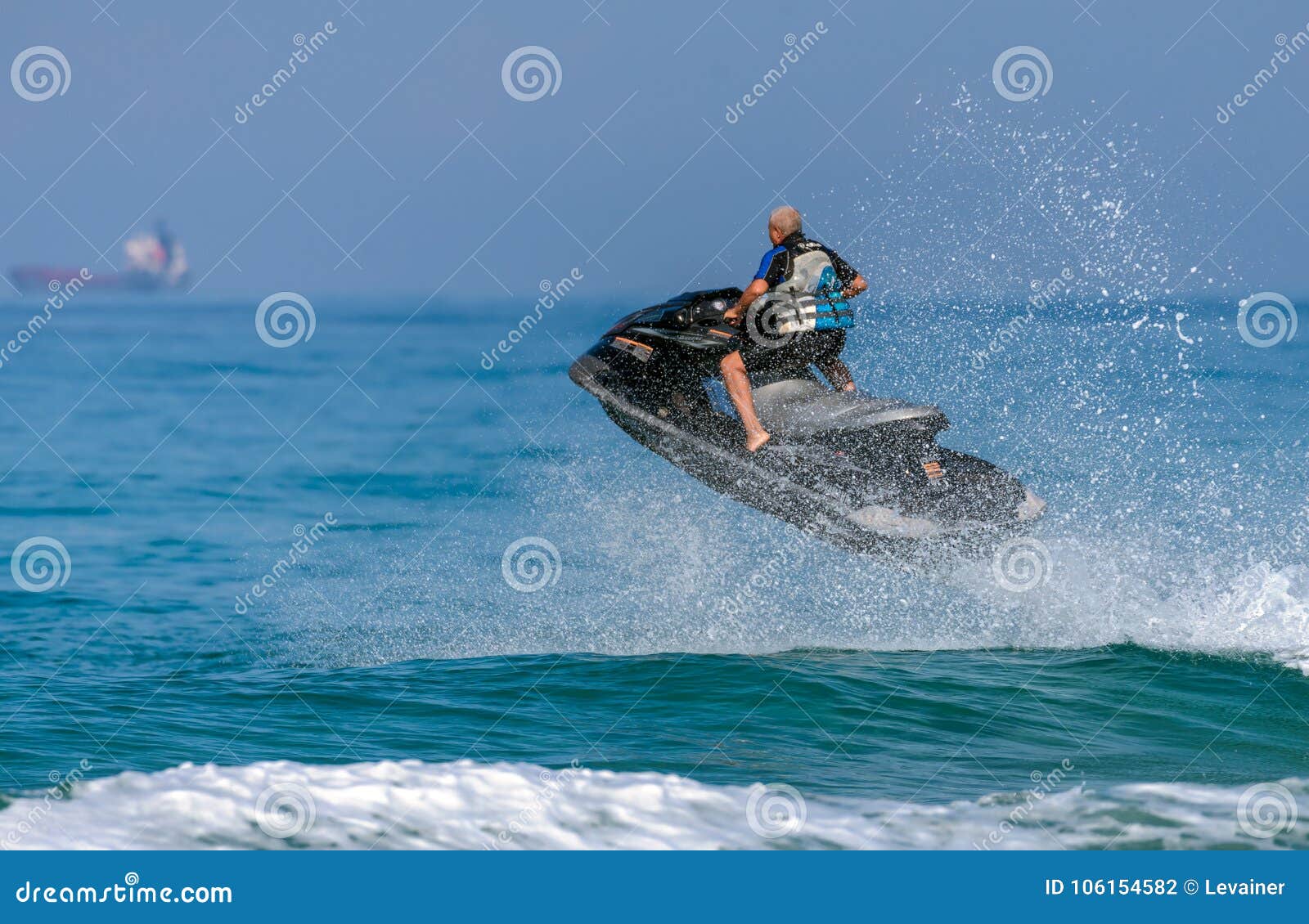 Water Motorcycle Pulls An Inflatable Raft. People Driving On Banana ...