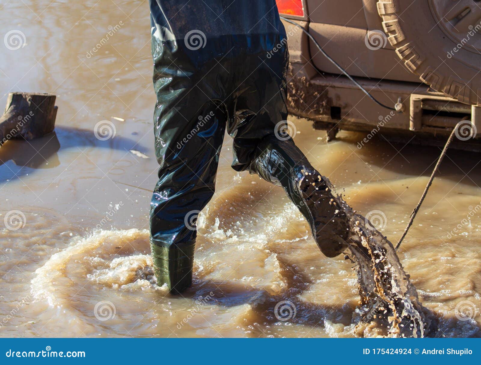 A Man in the Water Pulls Out a Car Stock Photo - Image of road, drive ...