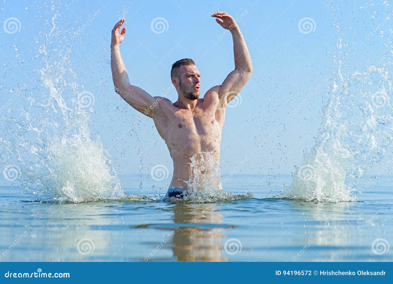 Man in the water splashes stock photo. Image of happiness - 94196572