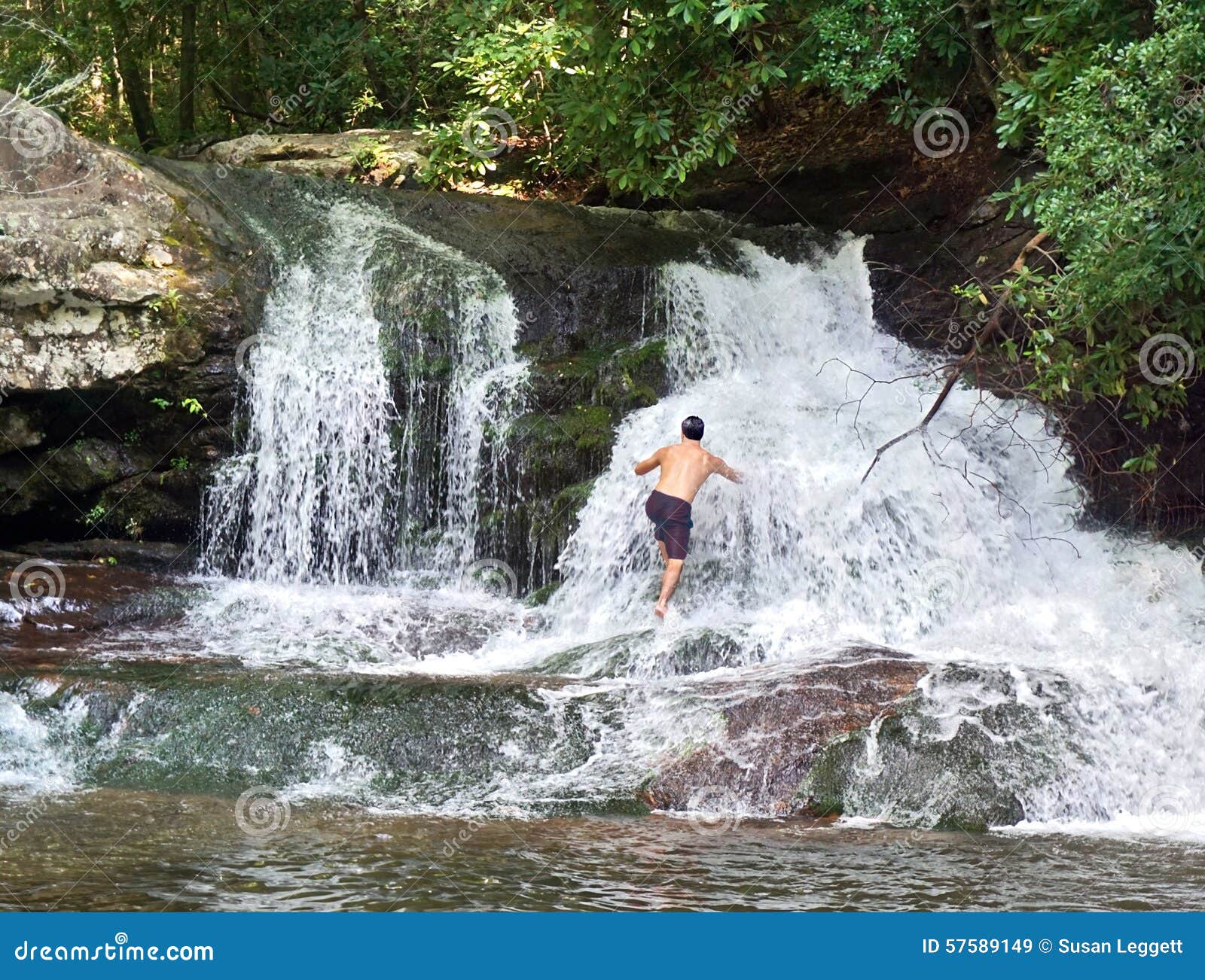 Man at a Waterfall stock image. Image of river, climbing - 57589149