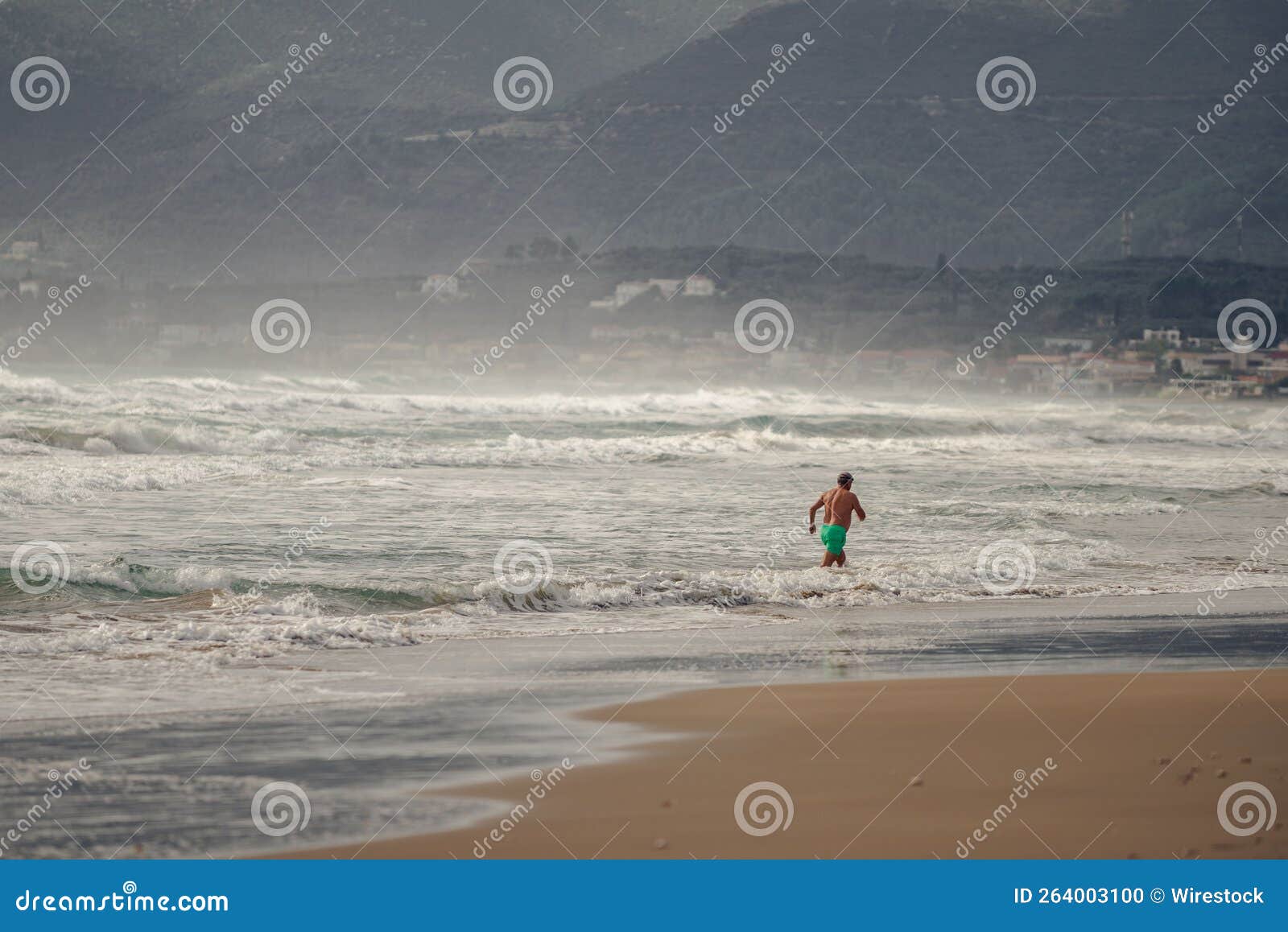 Man in the Waves at the Beach Stock Photo - Image of sandy, background ...