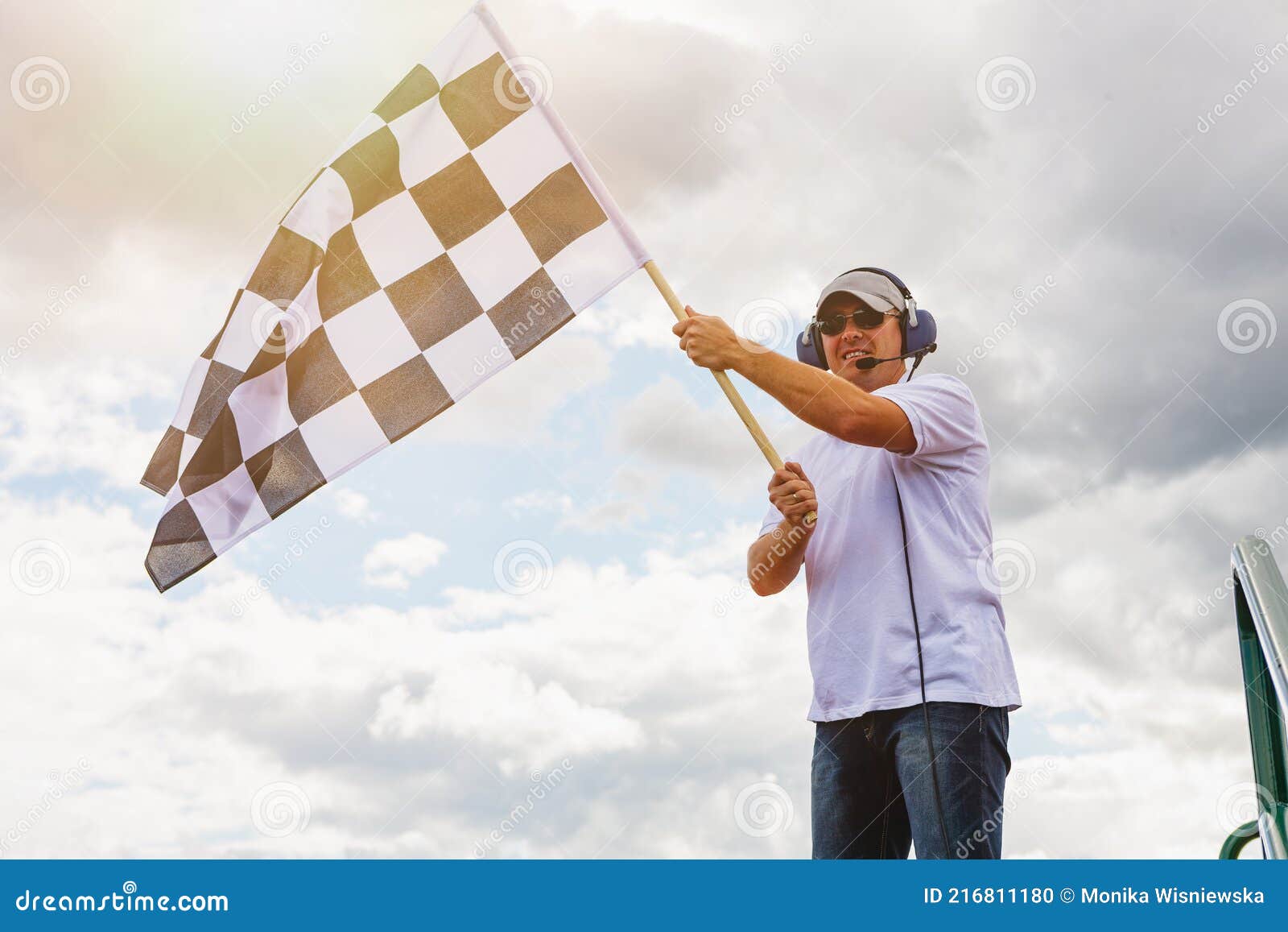 Man waves a checkered flag stock photo. Image of hand - 216811180