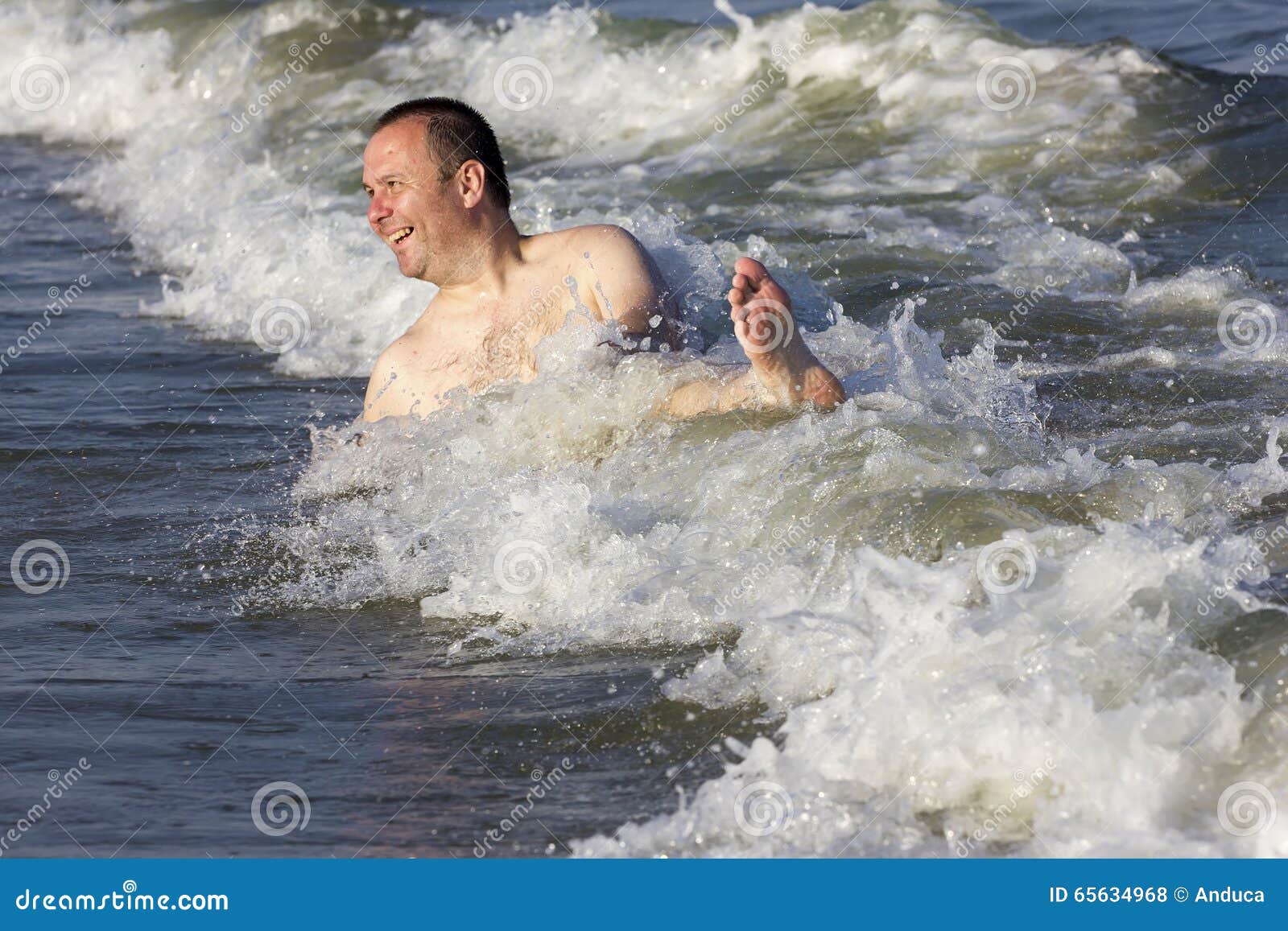Man in the waves stock photo. Image of life, feel, saver - 65634968