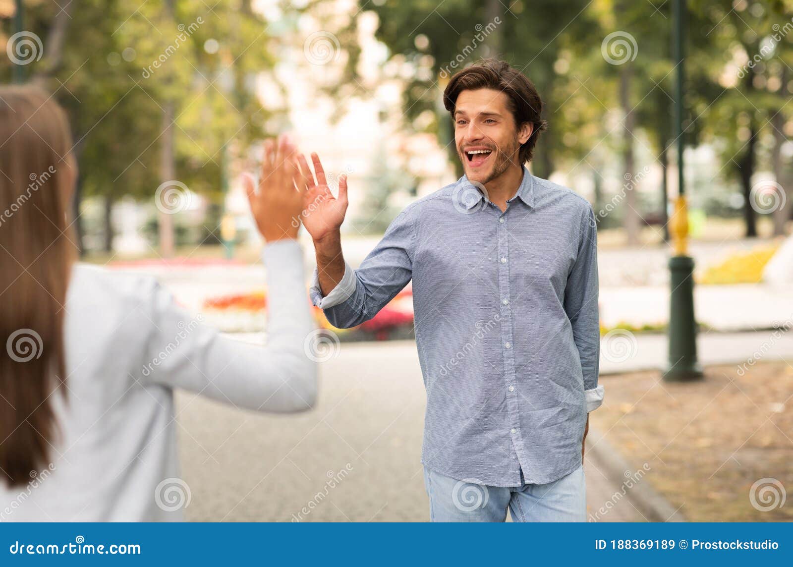 Man Waving Hello Gesture Meeting Female Friend Walking Outdoors Stock ... Man Waving Hello Gesture Meeting Female Friend Walking Outdoors Stock ...