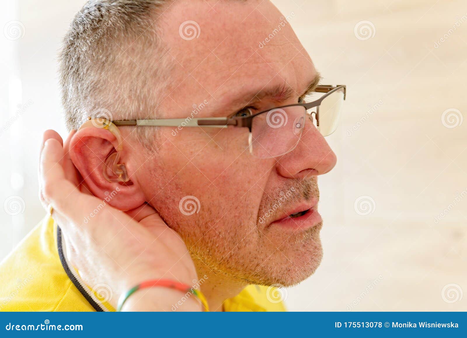 Man wearing deaf aid stock photo. Image of hand, technology - 175513078