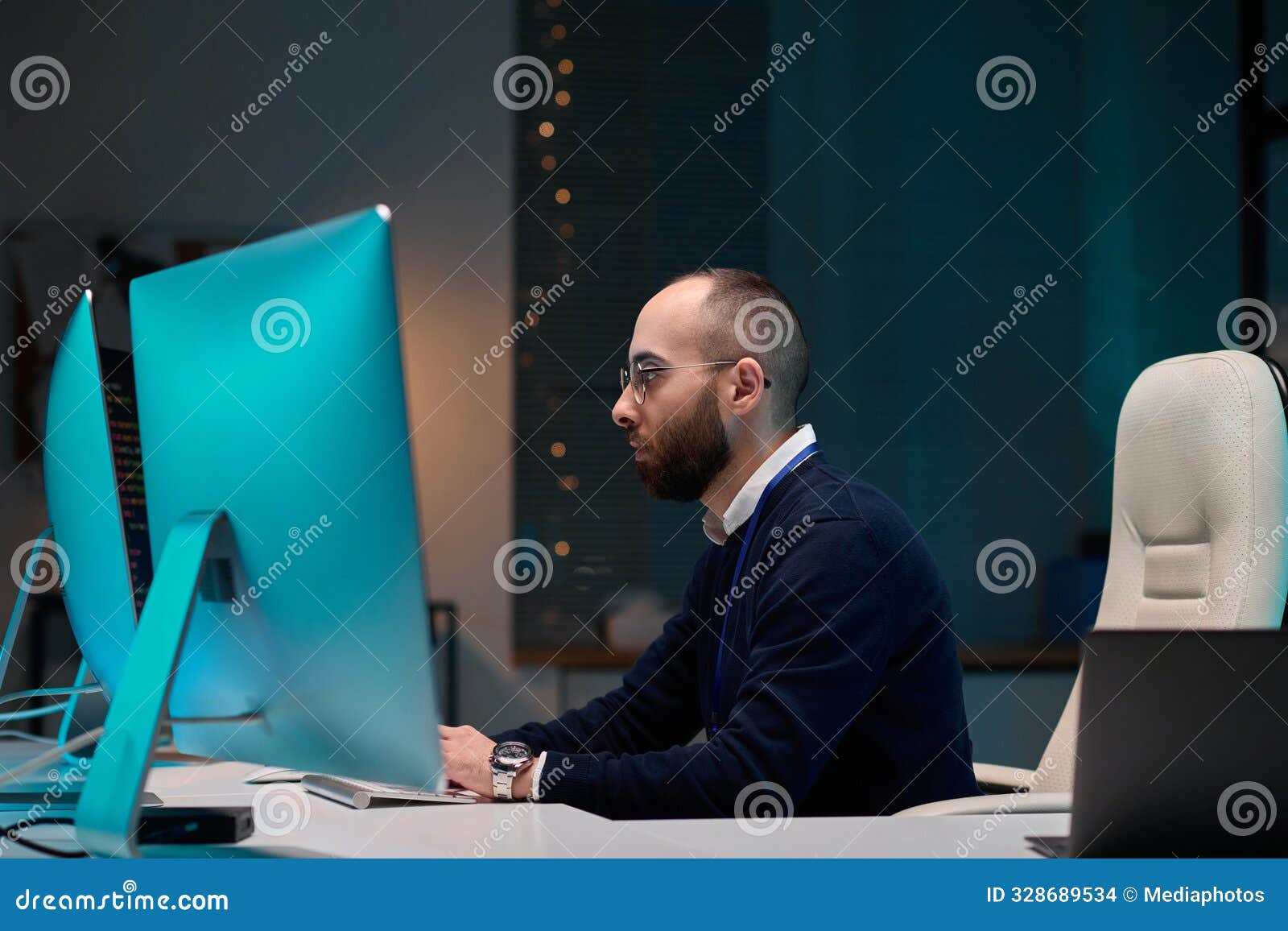 Man Wearing Glasses Using Computer in Blue Light Stock Photo - Image of ...