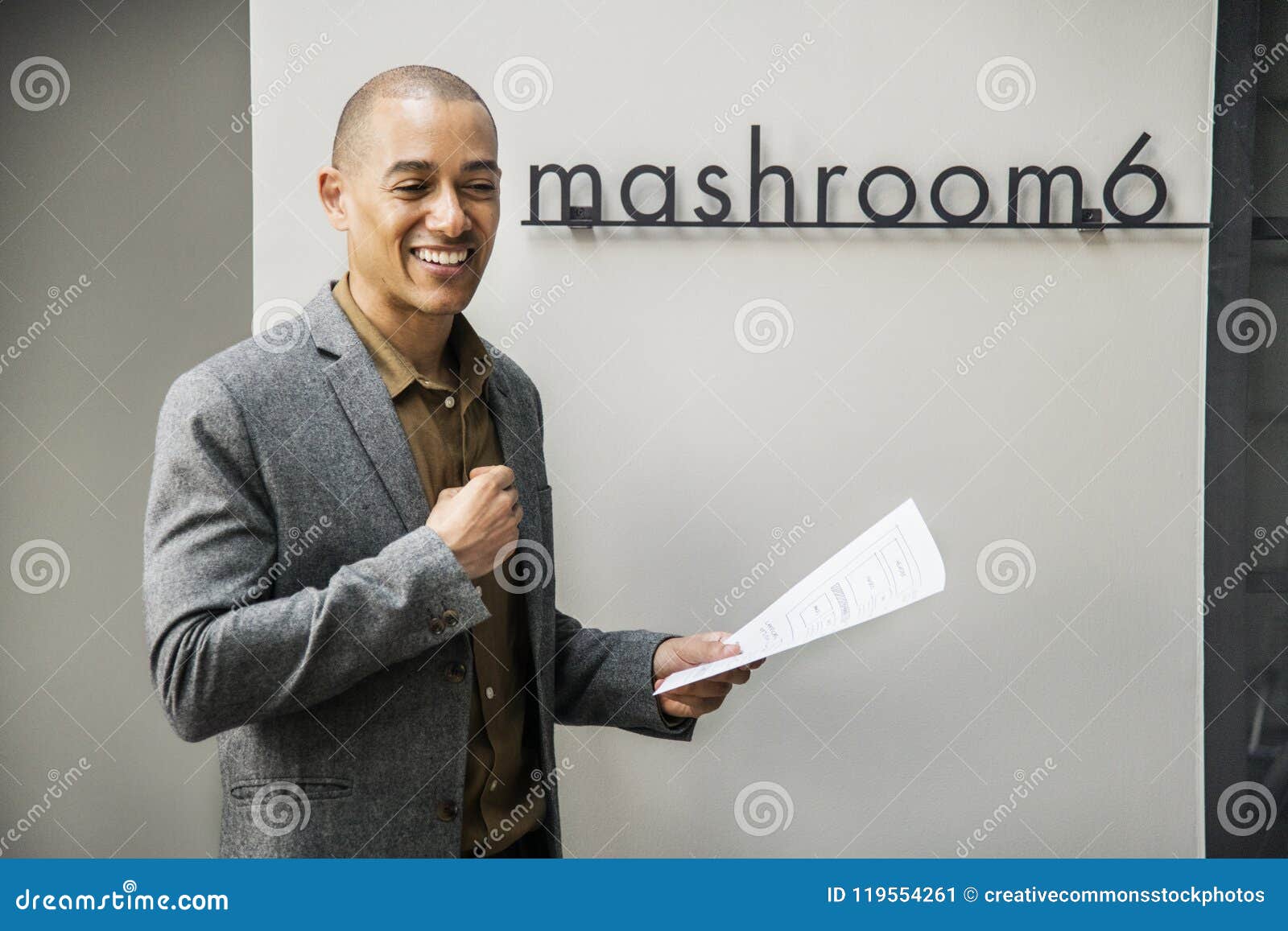 Man Wearing Grey Notched Lapel Suit Jacket Holding White Printer Paper ...