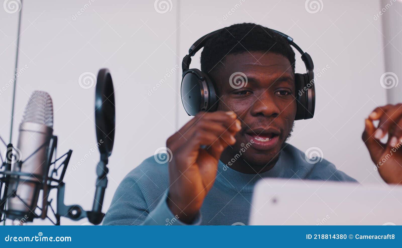 Man Wearing Headphones Taking an Online Class Using a Laptop and ...