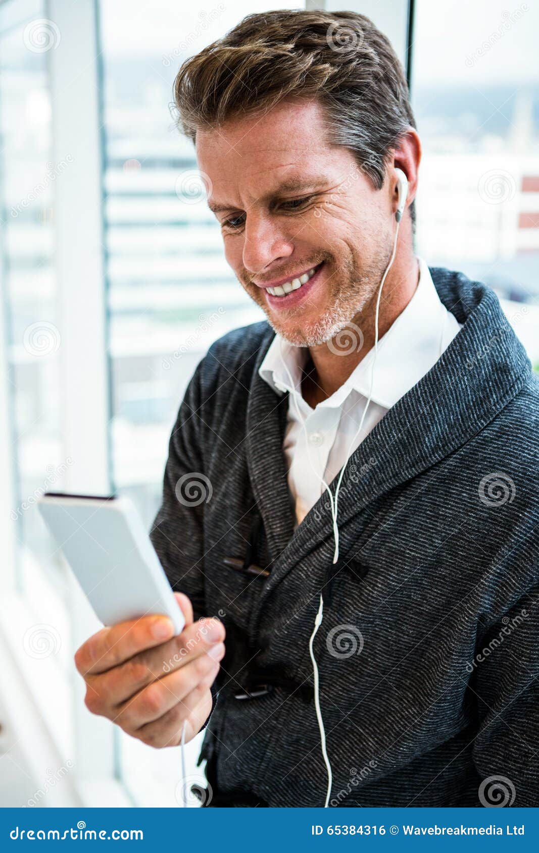 Man Wearing Headphones Using Mobile Phone Stock Photo - Image of ...