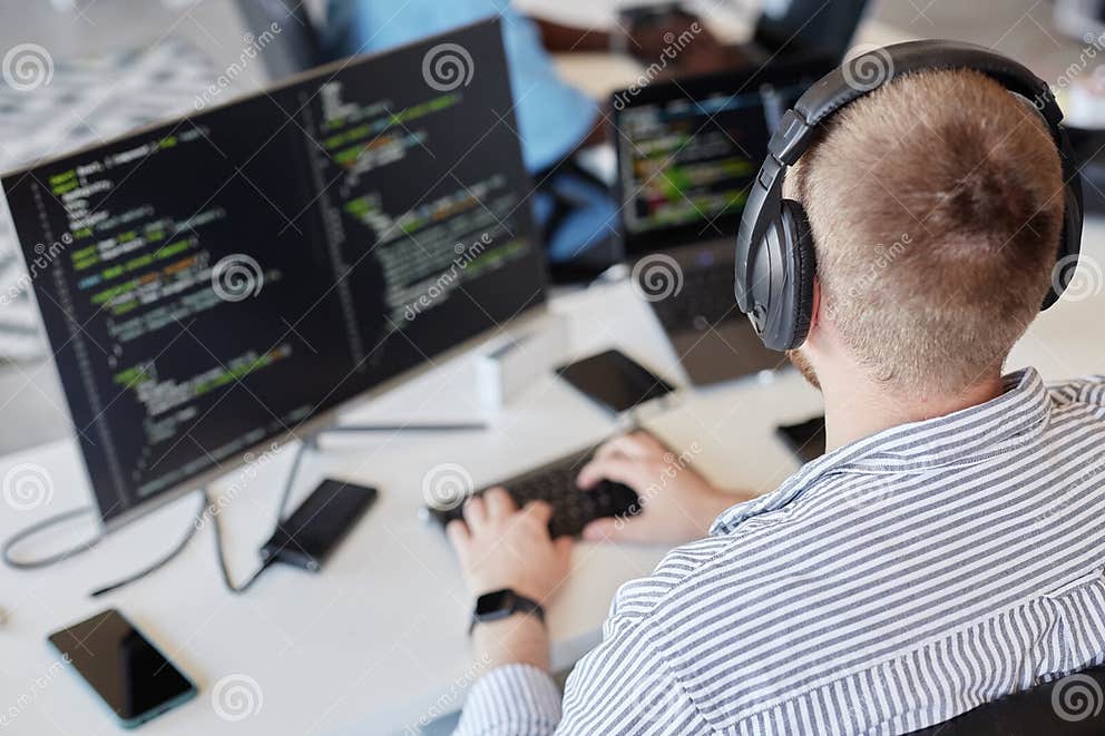 Man Wearing Headphones Working on Computer Programming Stock Image ...