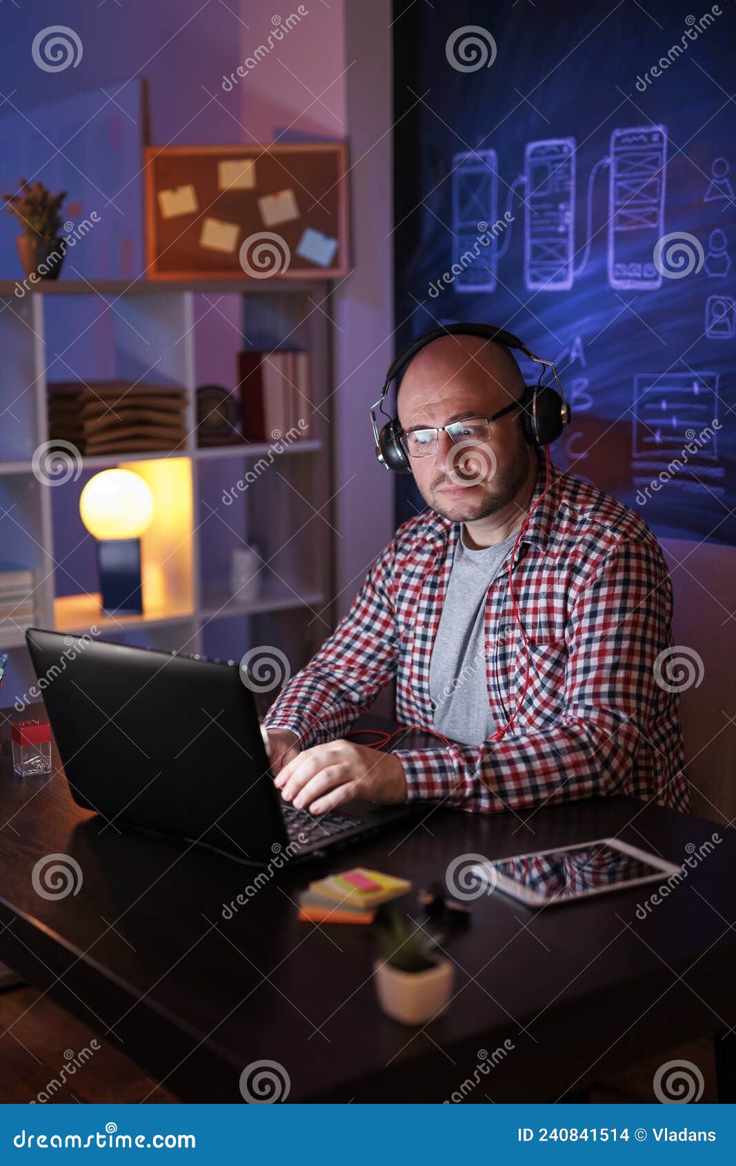Man Wearing Headset Working on Laptop Computer Late at Night Stock ...