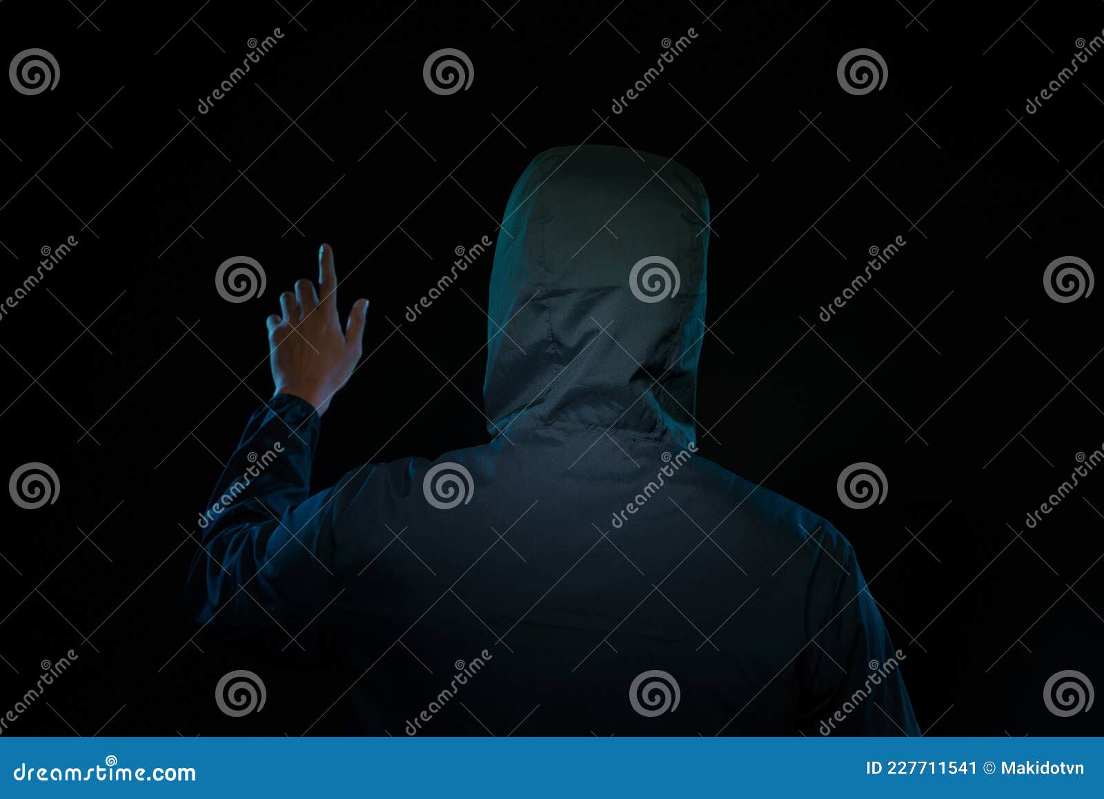 Man Wearing Hood in Dark Room. Hacker with Laptop Initiating the Hacker ...
