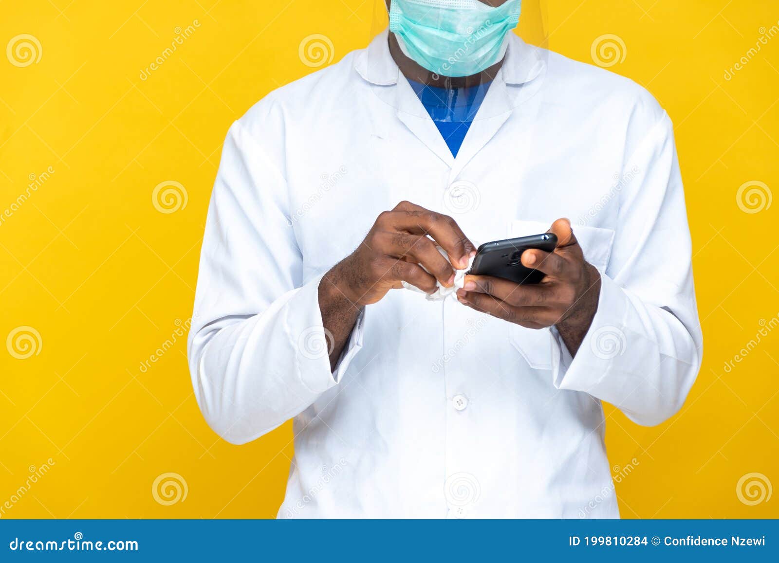 Man Wearing a Lab Coat, and Face Mask and Shield Cleaning the Surface ...