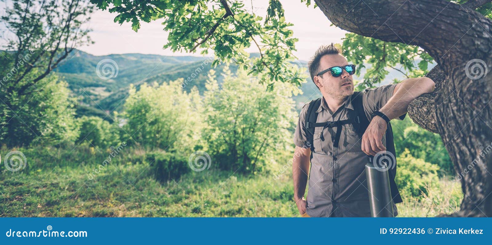 Man resting under the tree stock photo. Image of mountains - 92922436
