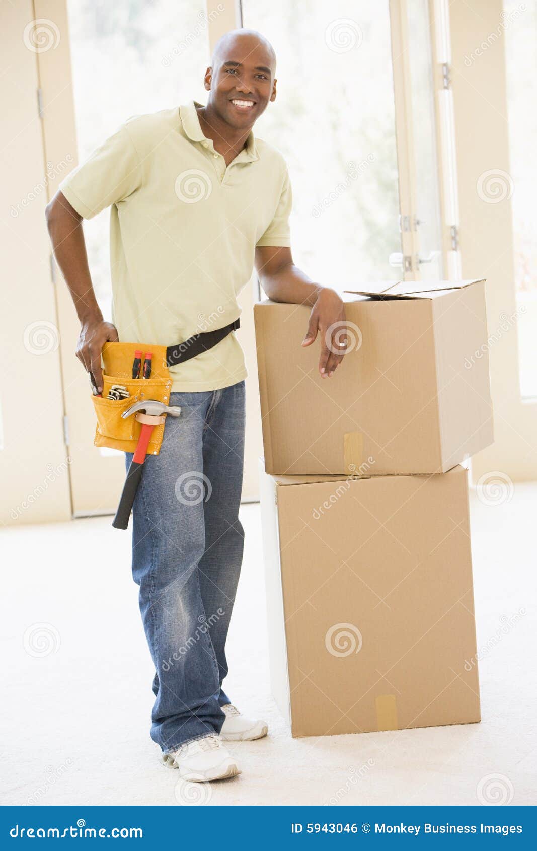 Man Wearing Tool Belt by Boxes in New Home Stock Photo - Image of ...
