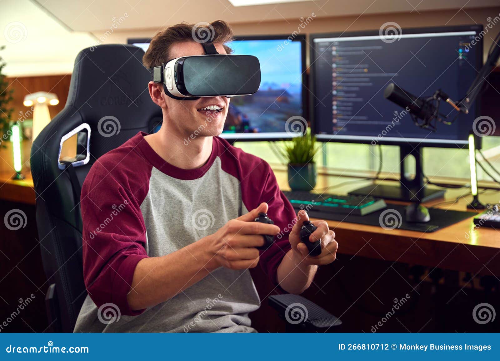Man Wearing Virtual Reality Headset Gaming at Home Sitting at Desk with ...