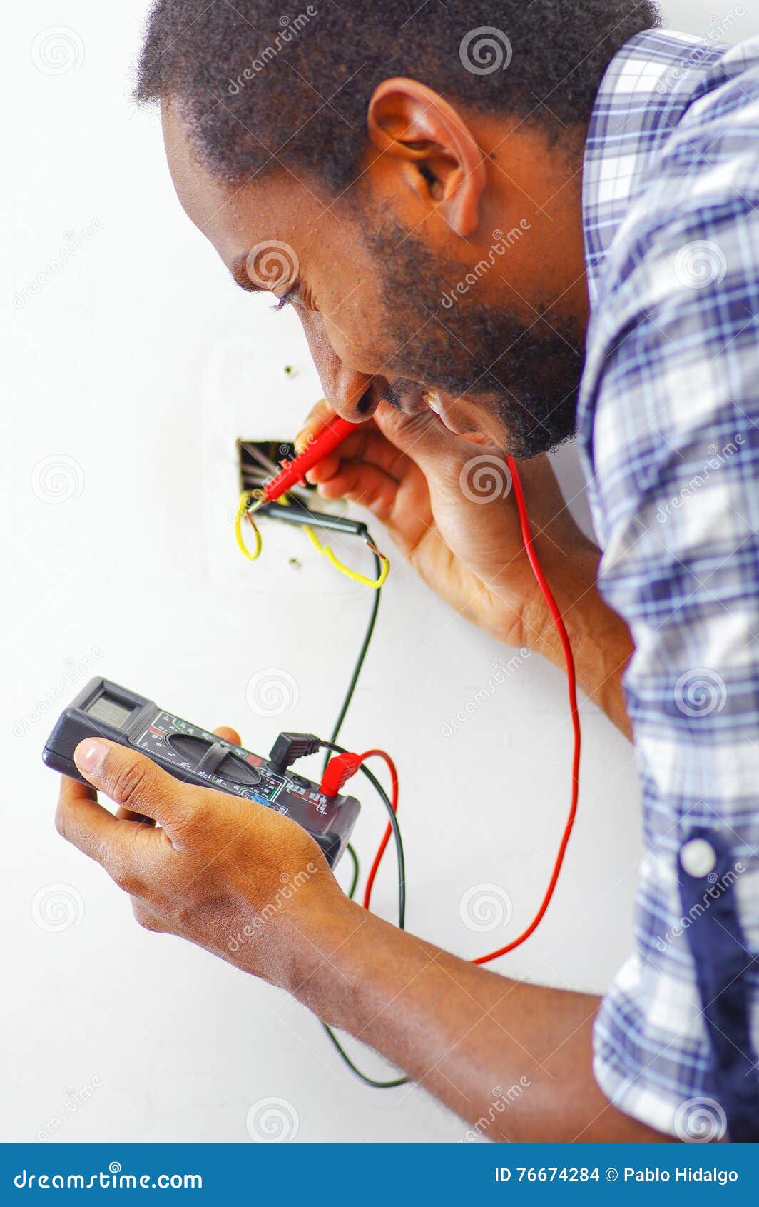 Man Wearing White and Blue Shirt Working on Electrical Wall Socket ...