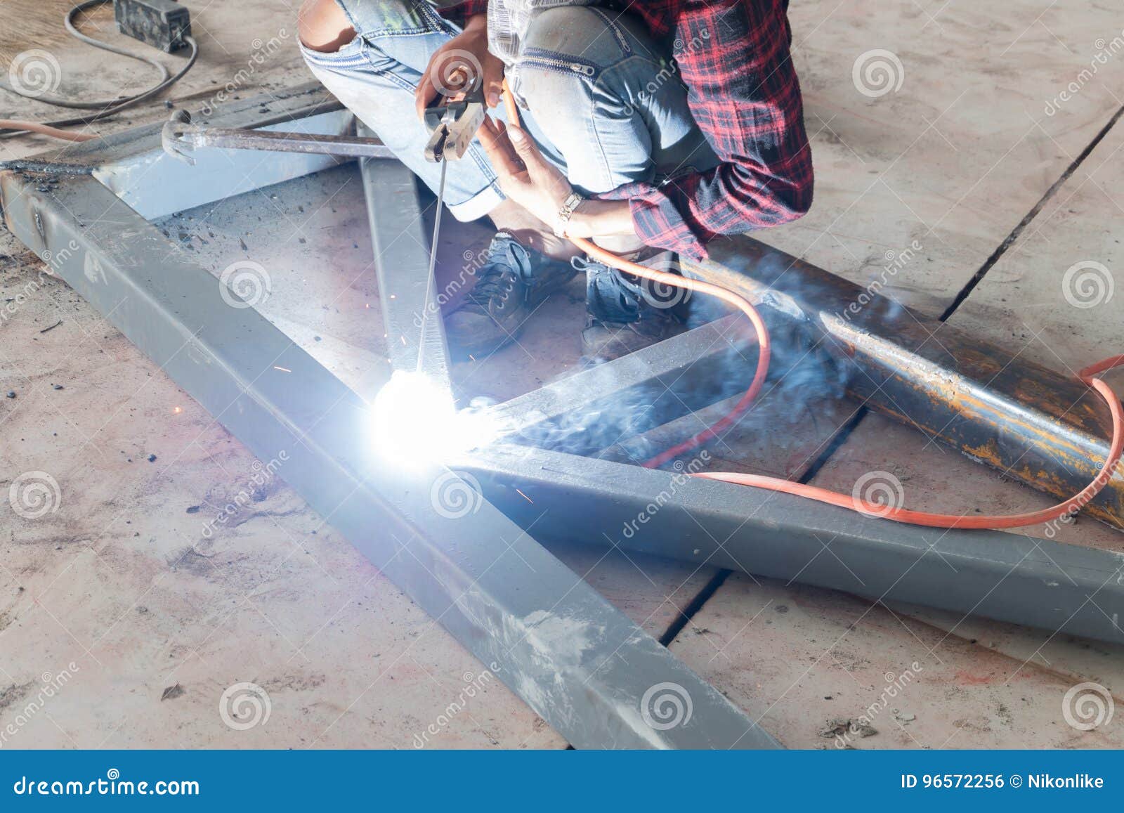 Man Weld a Metal with a Welding Machine. Stock Photo - Image of ...